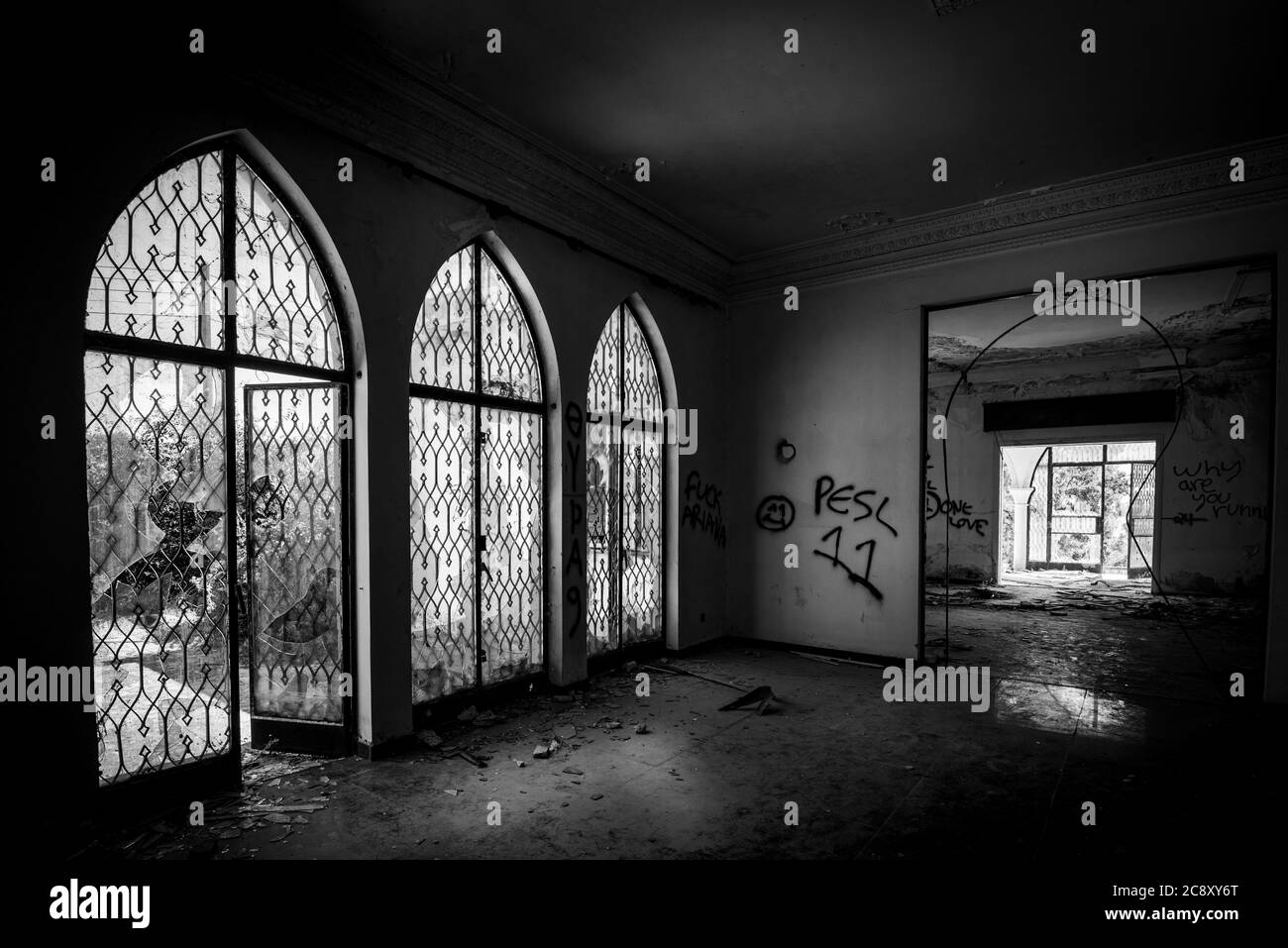 Abandoned house veranda room with view through broken windows and doors ...