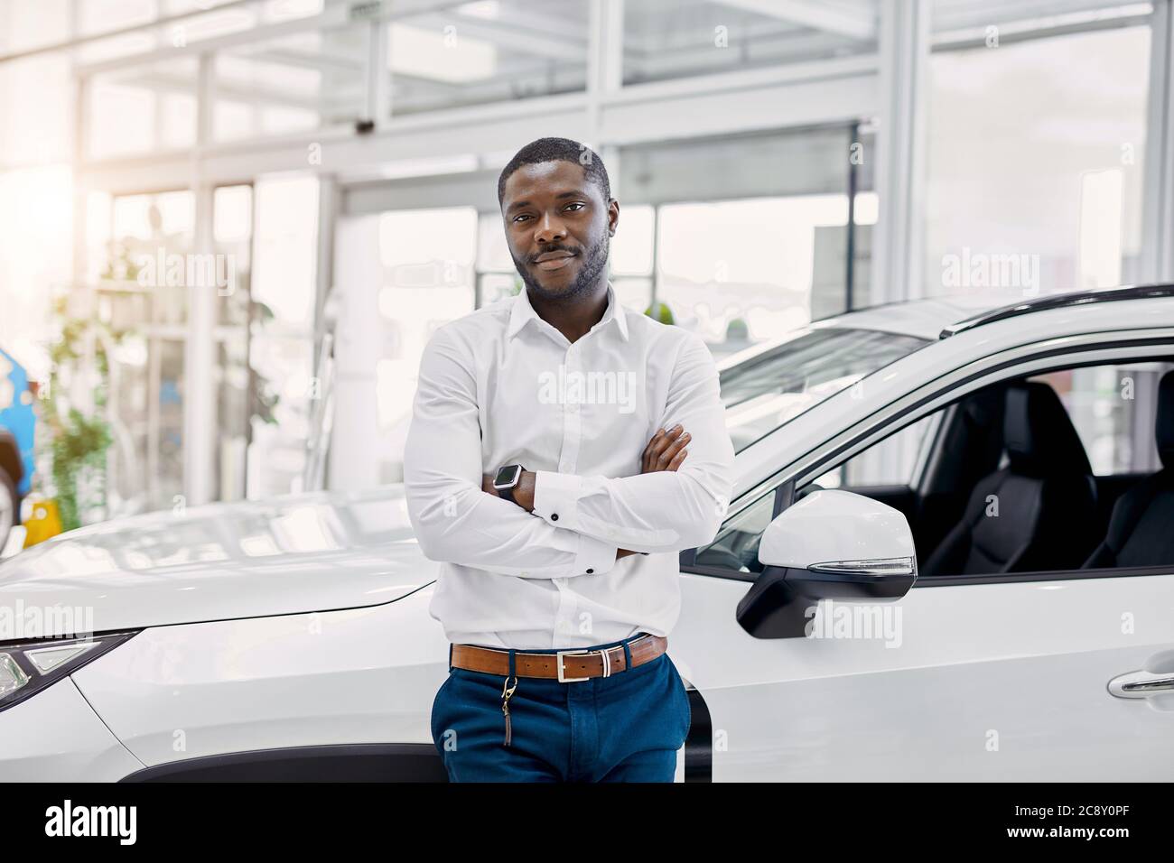 young black man happy with purchase in dealership, he is owner of ...