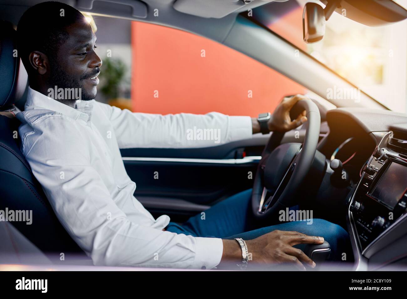handsome rich african man try himself behind the wheel of new ...