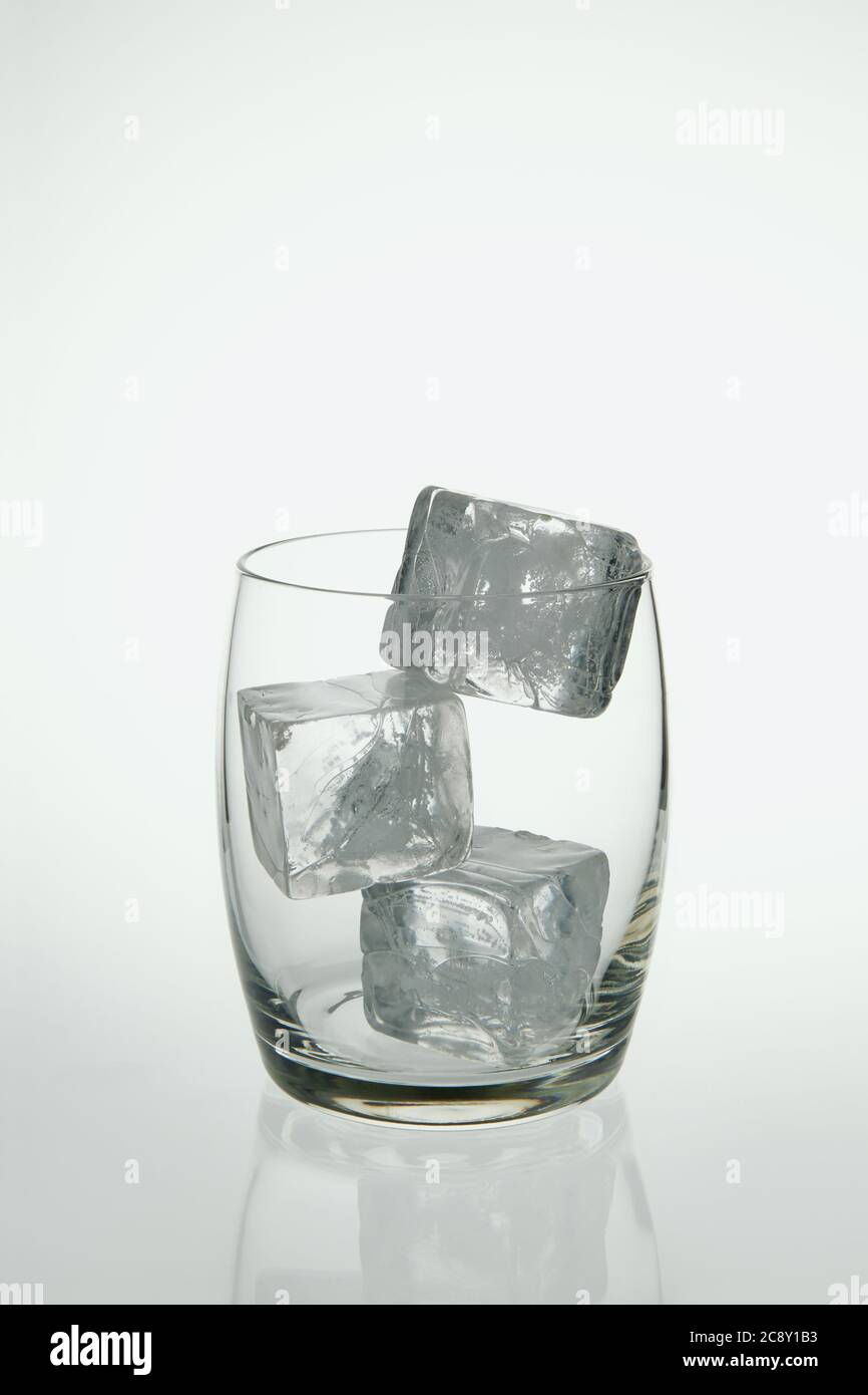 Photograph of three fake ice cubes in a glass tumbler on a light ...