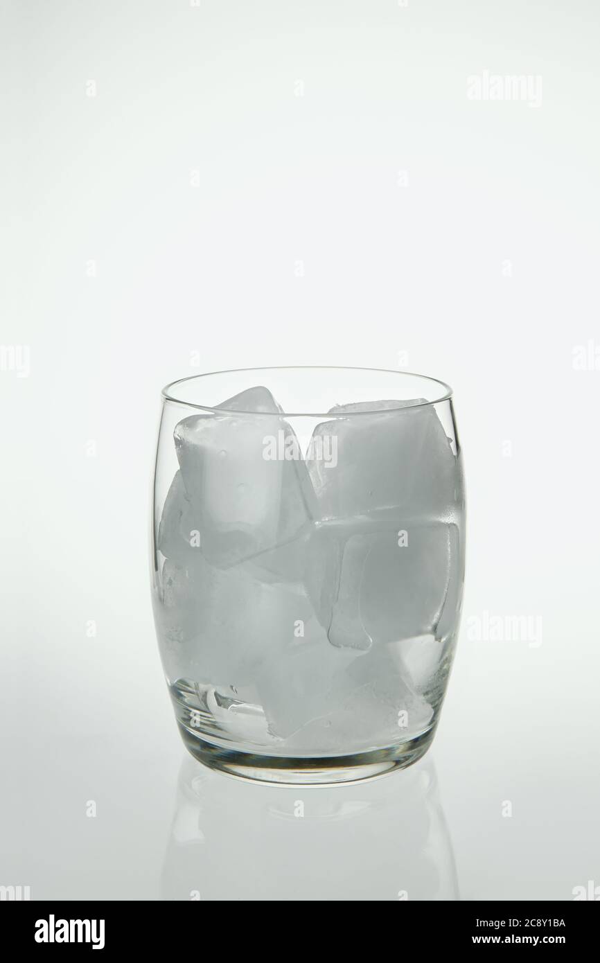 Photograph of a glass full of ice cubes on a light background Stock ...