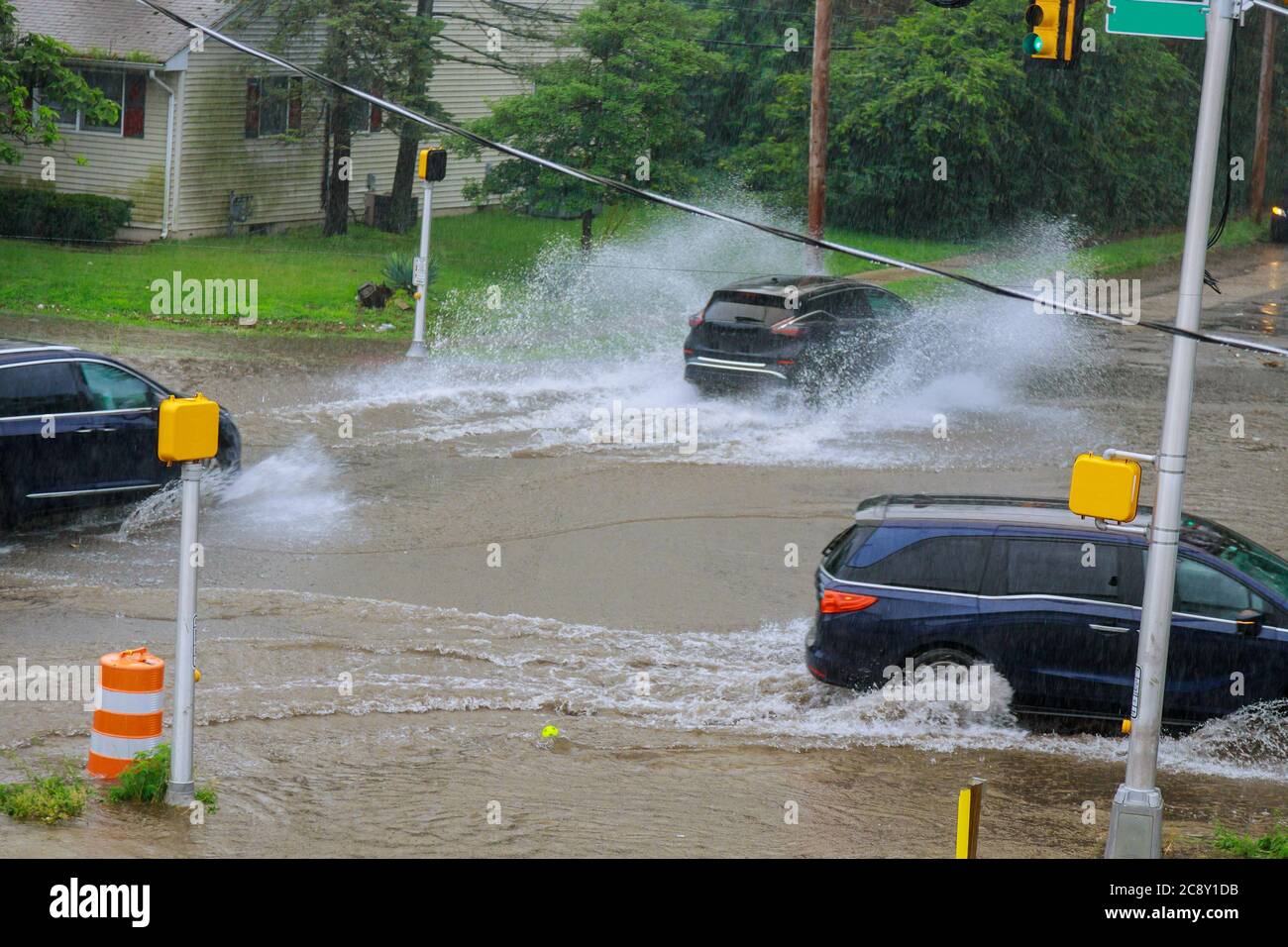 Water splashes street flooded heavy rain on residential city street ...