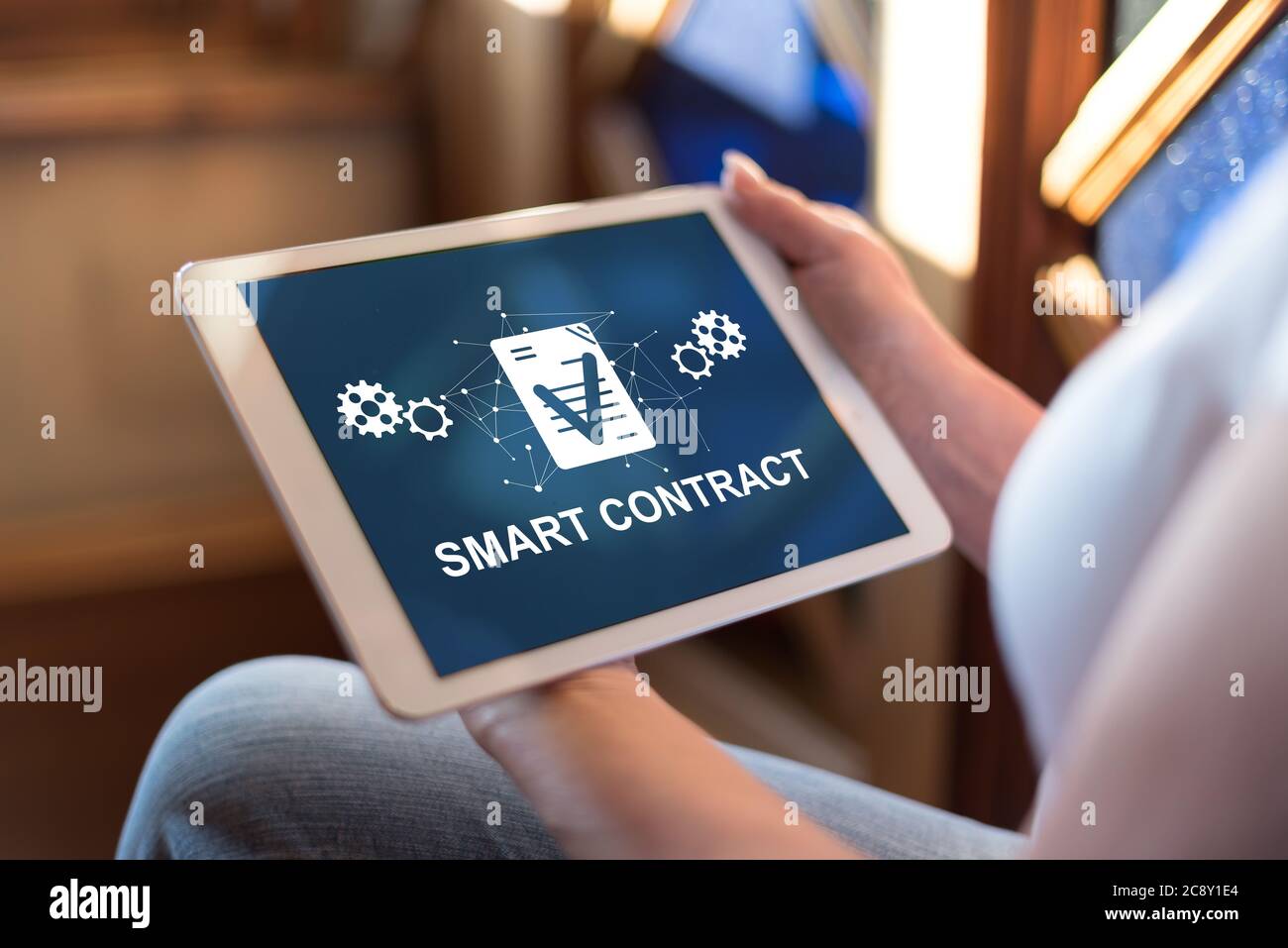 Woman holding a tablet showing smart contract concept Stock Photo - Alamy