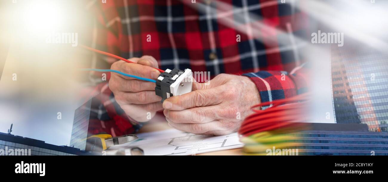 Electrician hands connecting a wire into a power socket; multiple ...