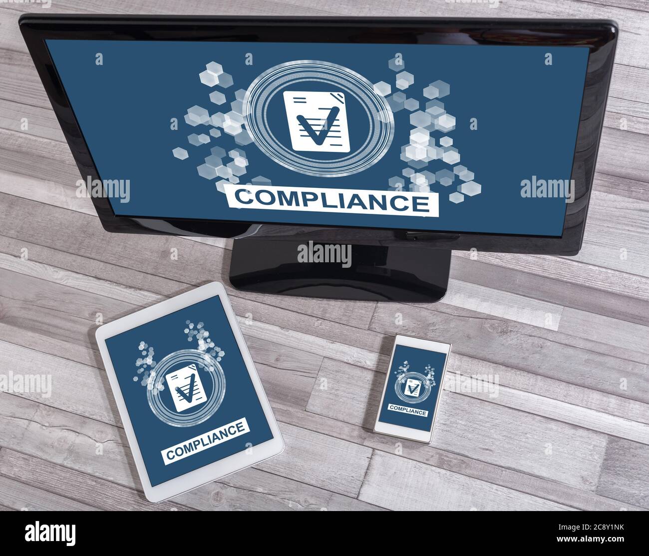 Compliance concept shown on different information technology devices ...