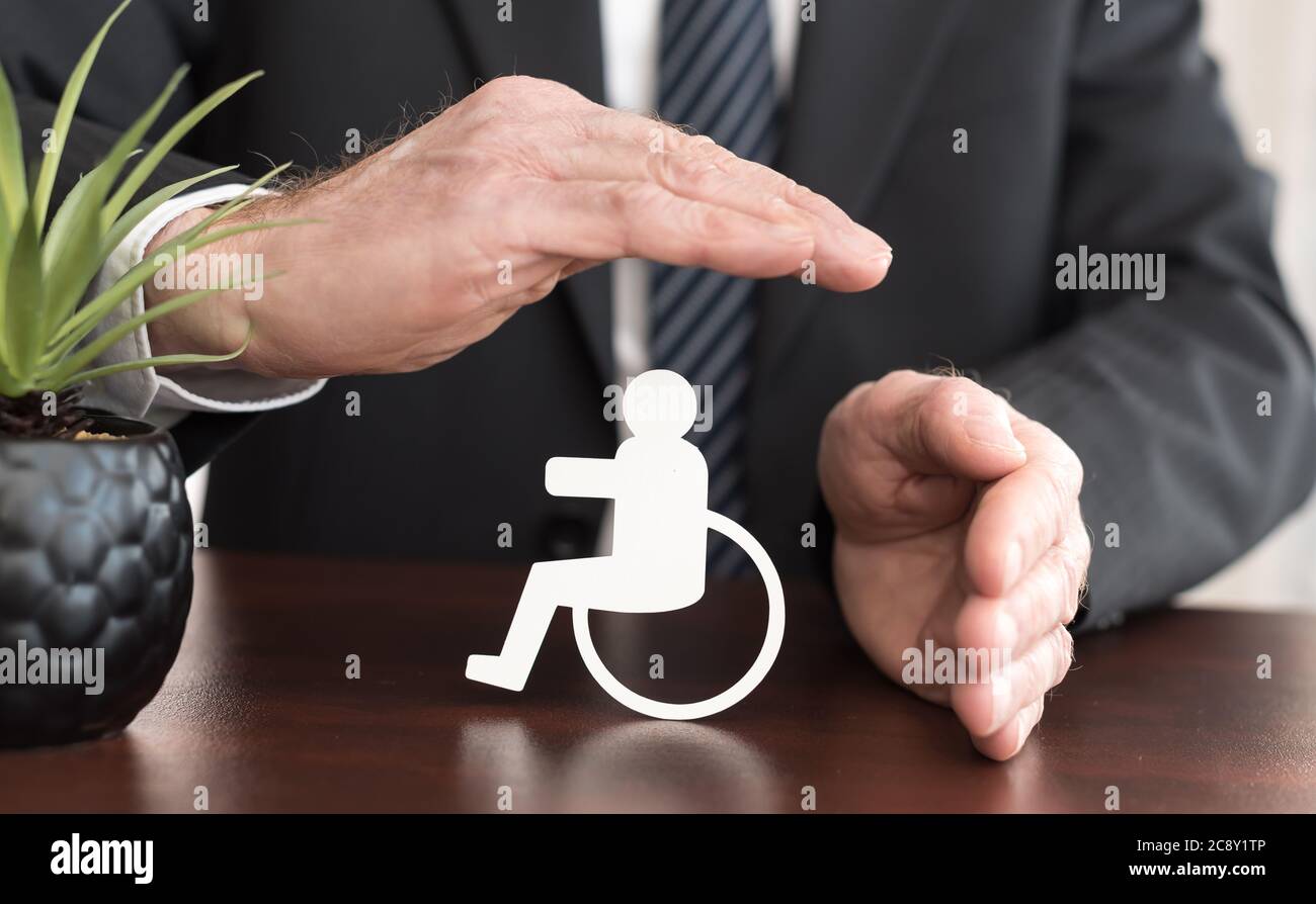 Insurer protecting a disabled person with his hands Stock Photo - Alamy