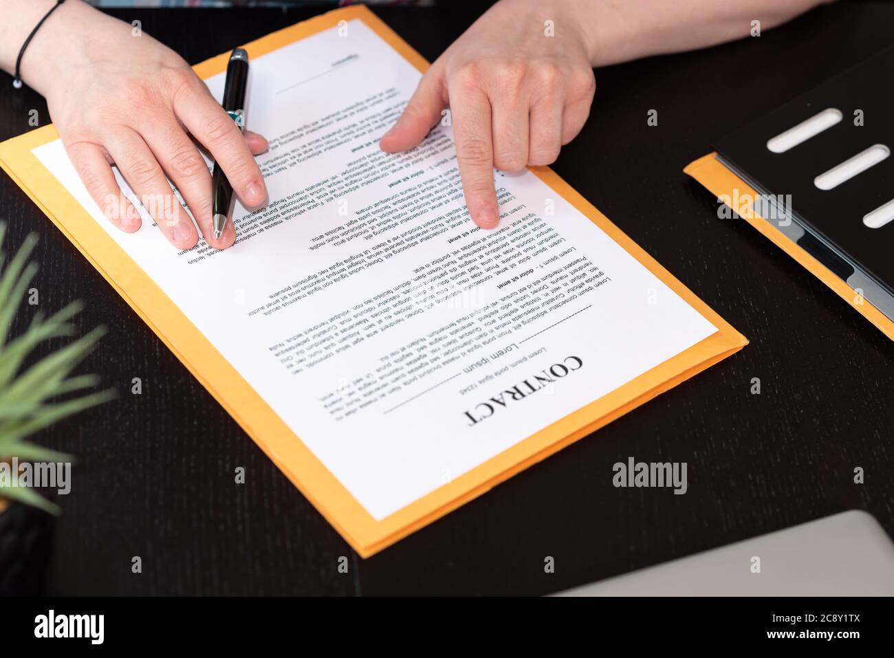 Young female lawyer checking contract Stock Photo - Alamy