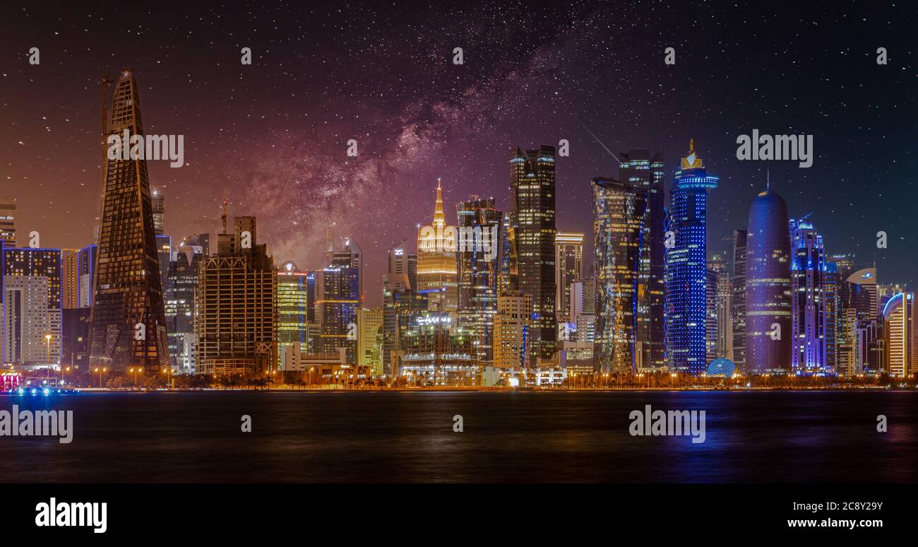Doha Qatar skyline at night showing skyscrapers and lights reflected in ...