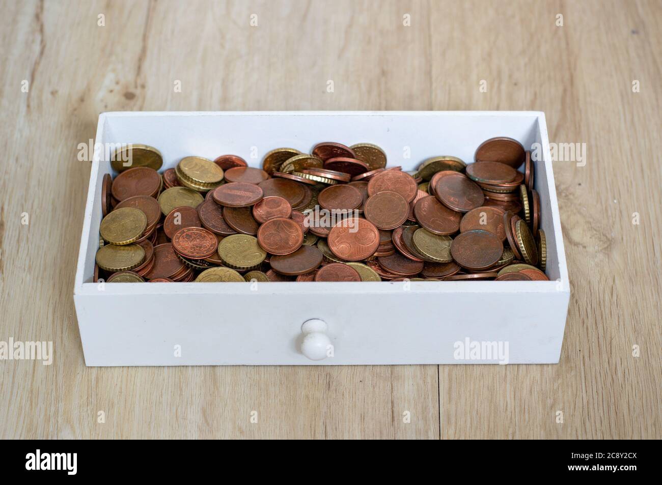 coins in a wooden box. European small change Stock Photo - Alamy