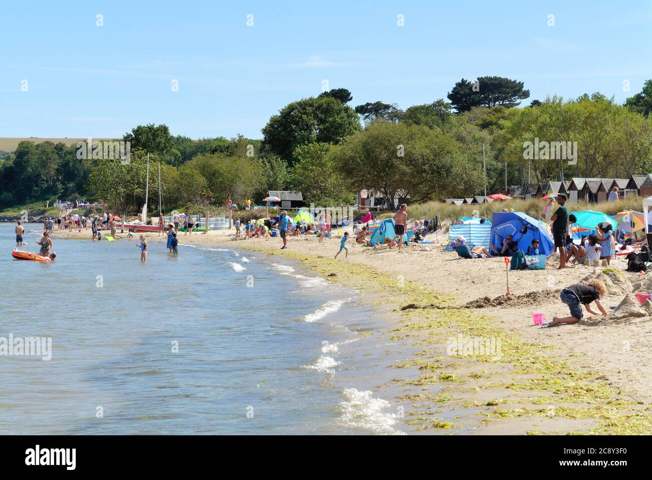 A crowded Knoll beach at Studland Bay on a hot sunny summers day ...
