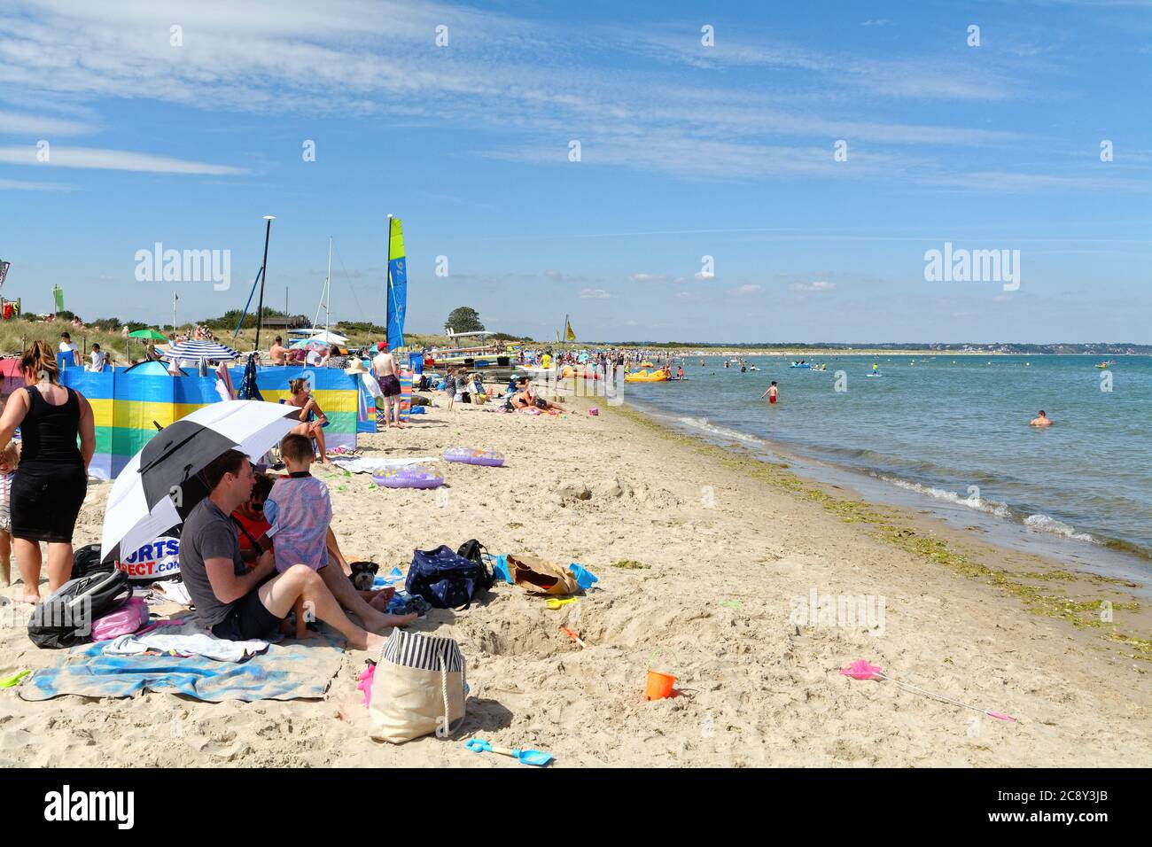 A crowded Knoll beach at Studland Bay on a hot sunny summers day ...