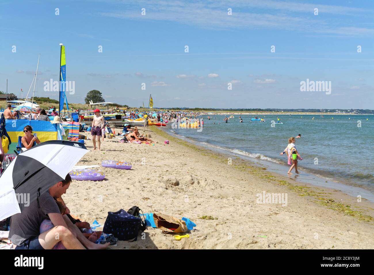 A crowded Knoll beach at Studland Bay on a hot sunny summers day ...