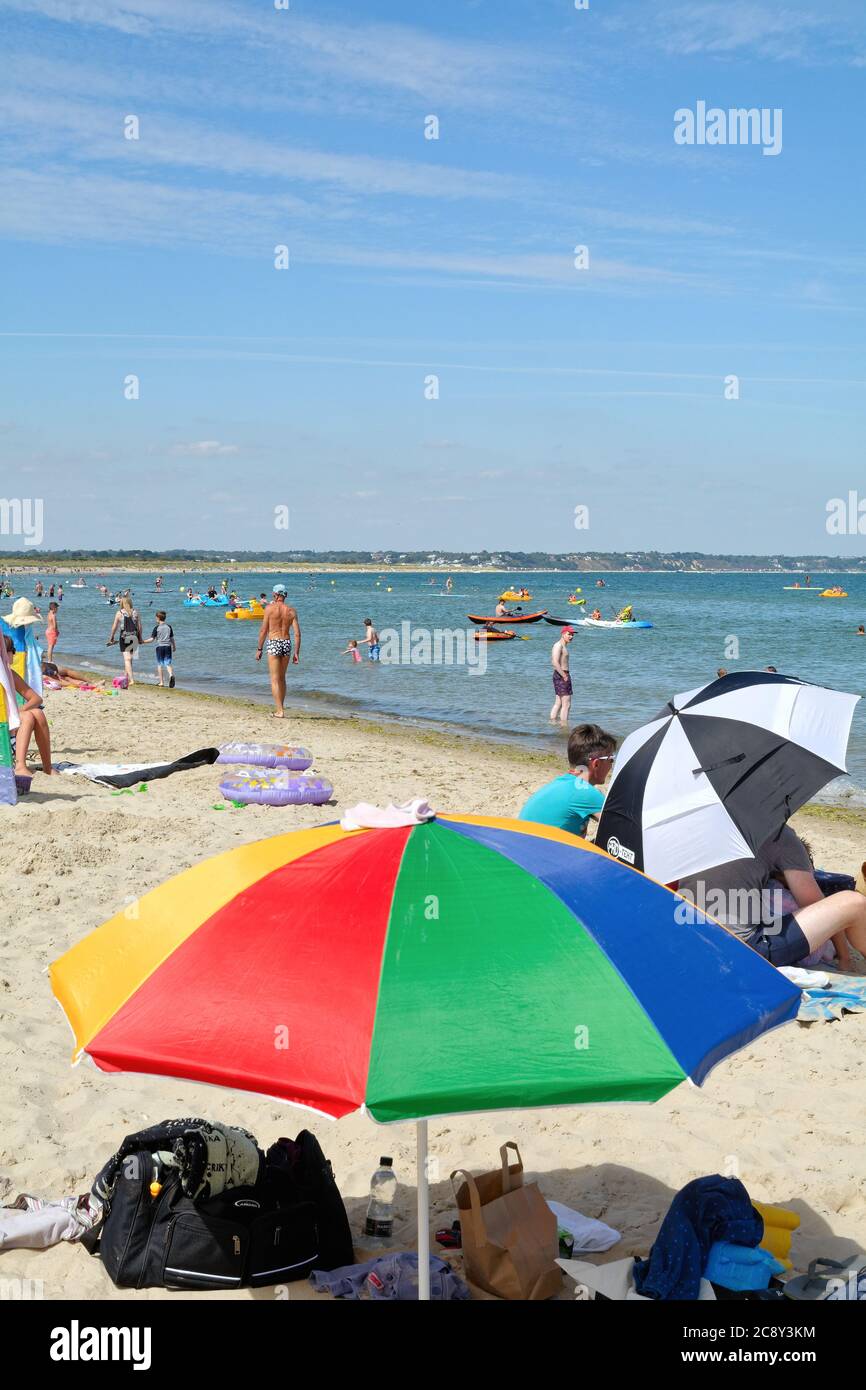 A crowded Knoll beach at Studland Bay on a hot sunny summers day ...