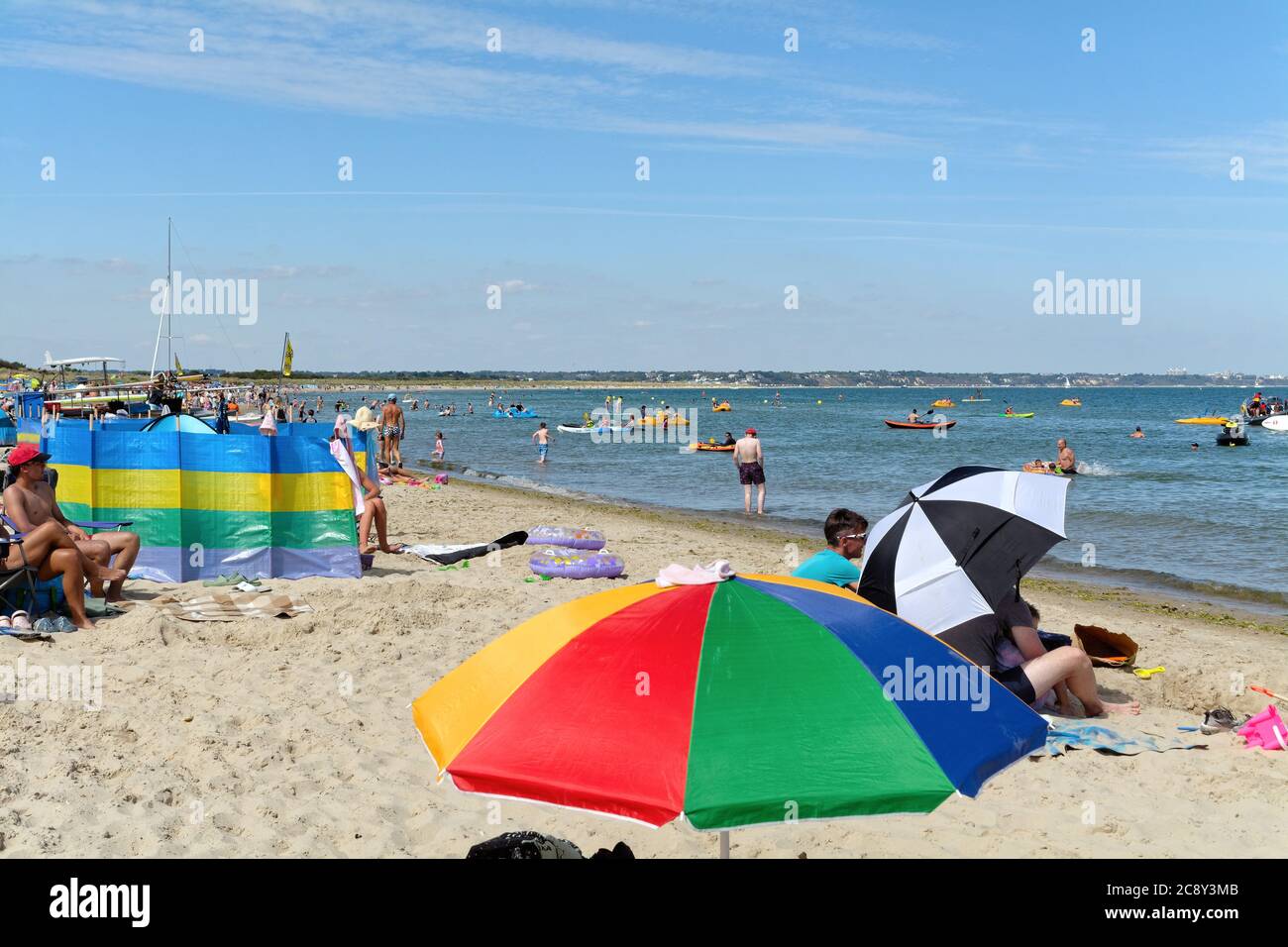 A crowded Knoll beach at Studland Bay on a hot sunny summers day ...