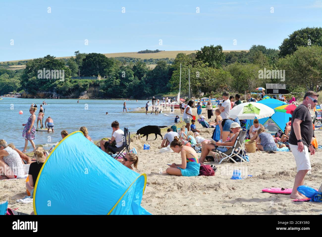 A crowded Knoll beach at Studland Bay on a hot sunny summers day ...