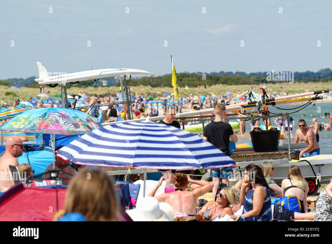A crowded Knoll beach at Studland Bay on a hot sunny summers day ...
