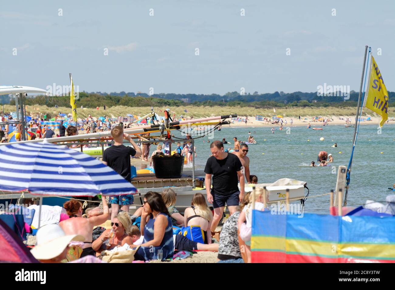 A crowded Knoll beach at Studland Bay on a hot sunny summers day ...