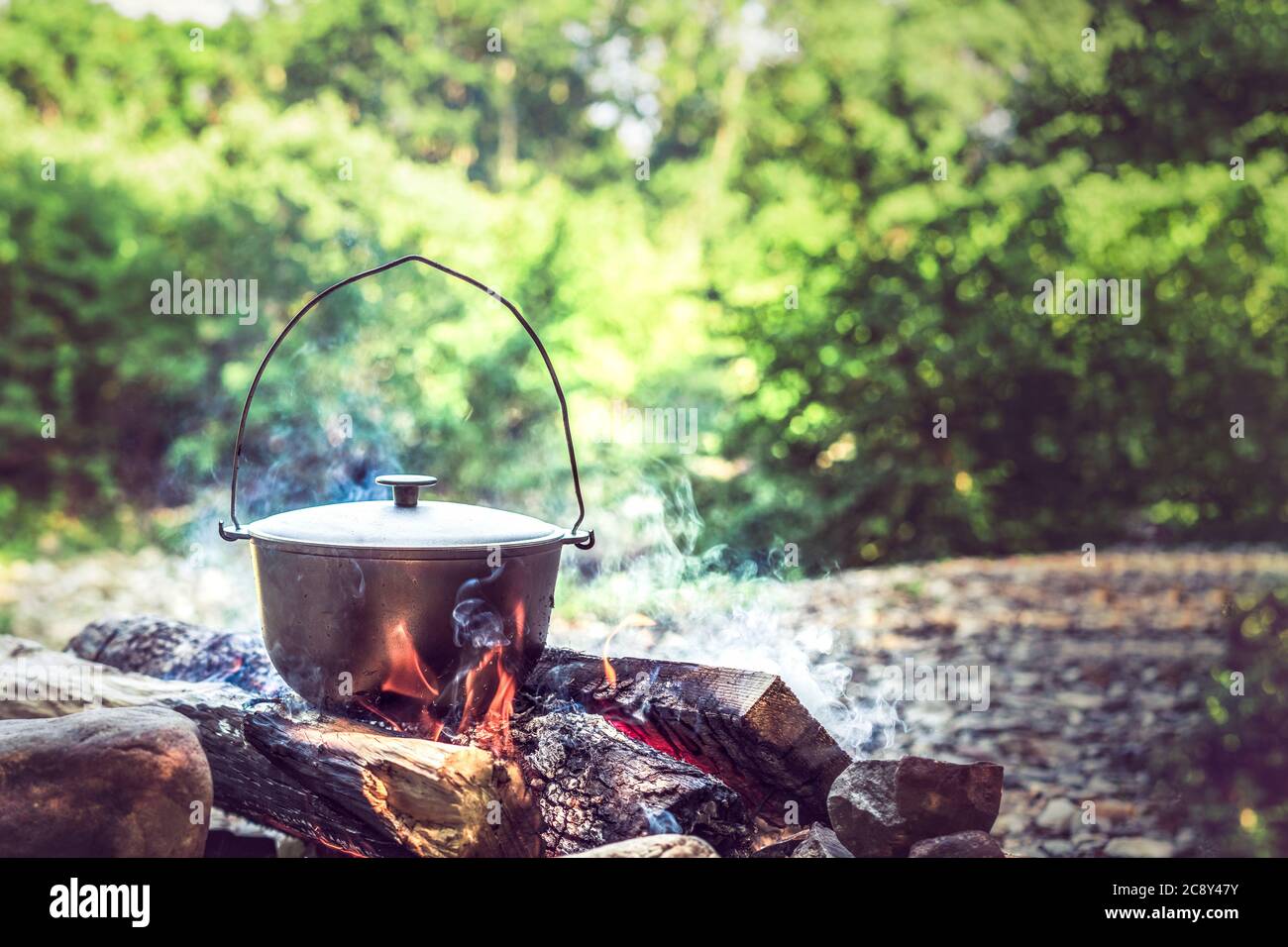 Traveling, tourism, picnic cooking, cooking in a cauldron on the fire ...