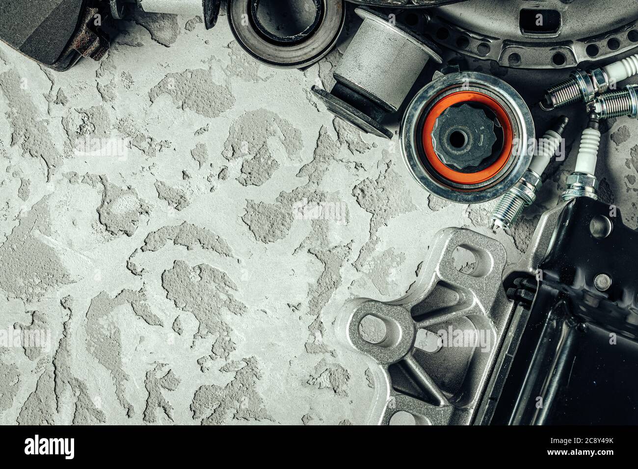 Car parts on grey textured concrete background Stock Photo - Alamy