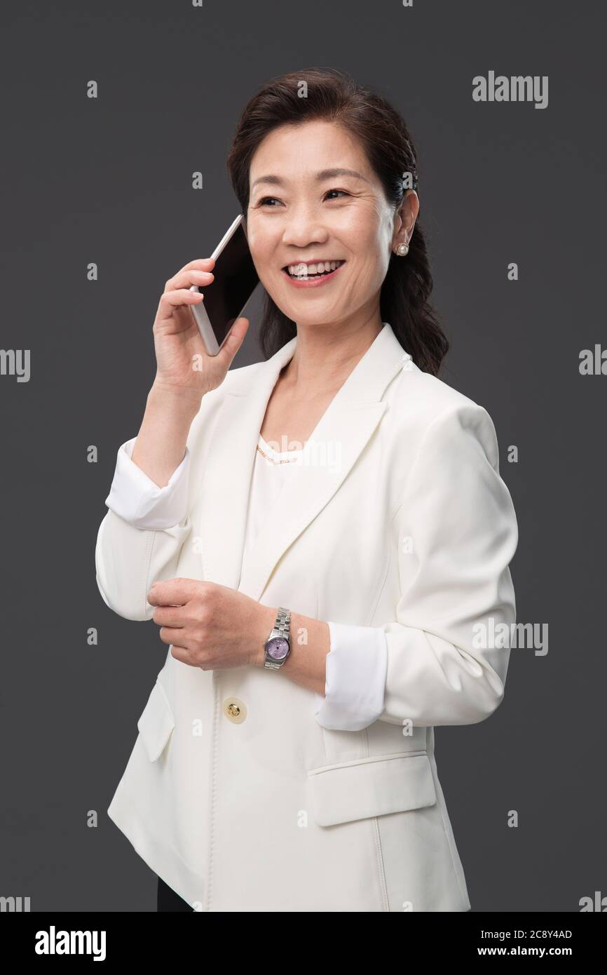 Middle-aged lady on the phone business Stock Photo - Alamy