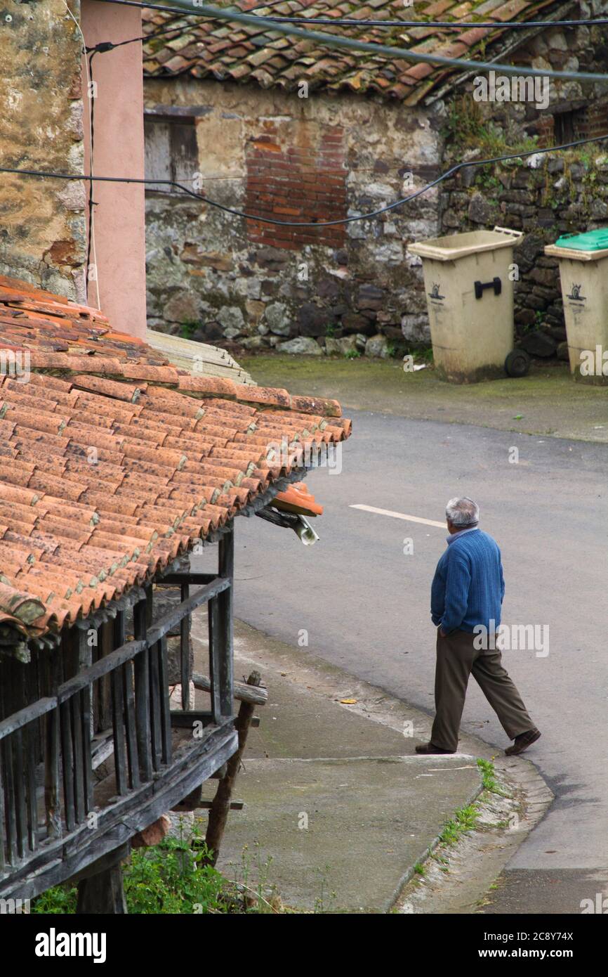 Older man walking through town without people Stock Photo - Alamy