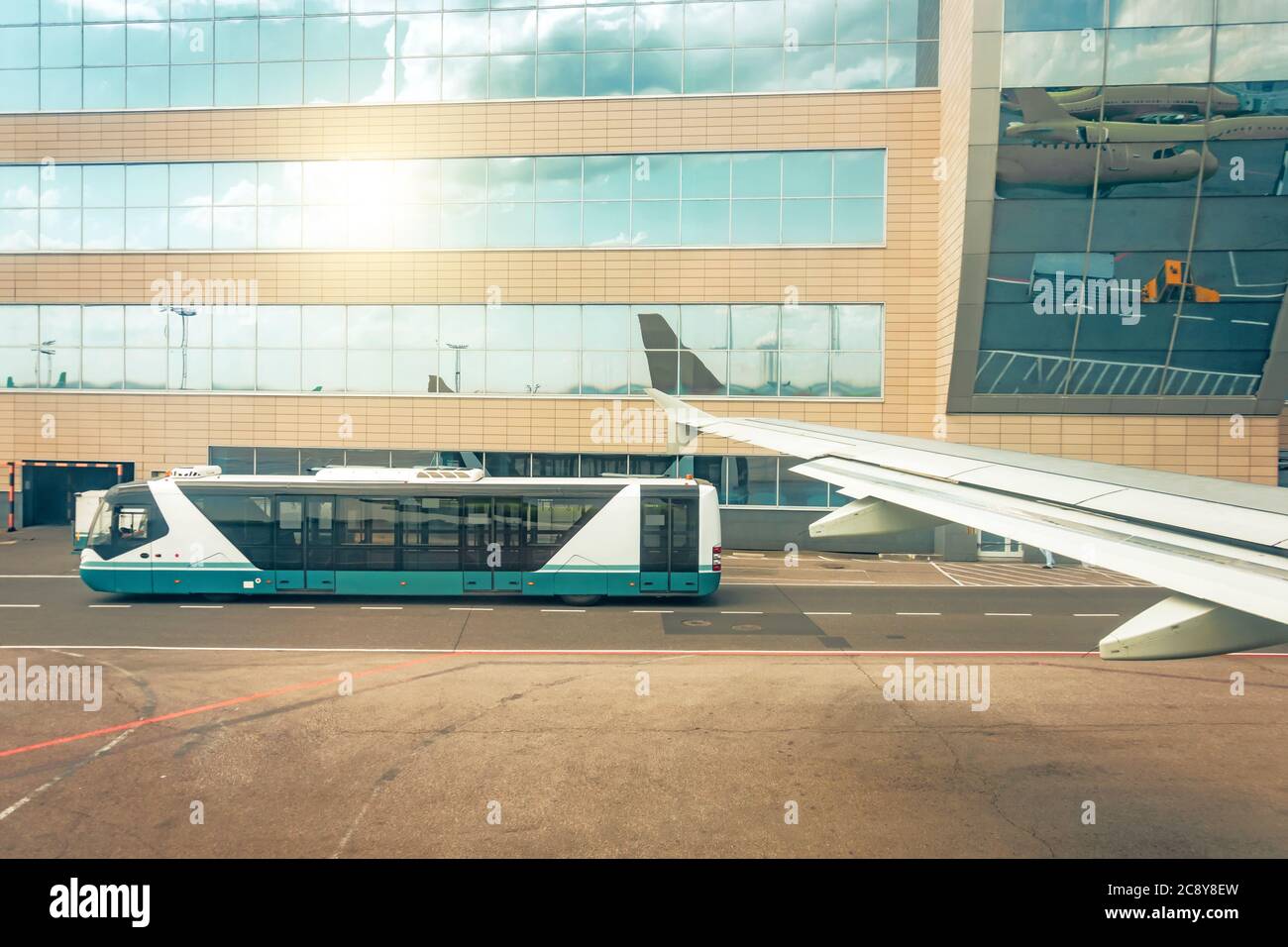 View from an airplane wing of a passenger bus passing by in the ...