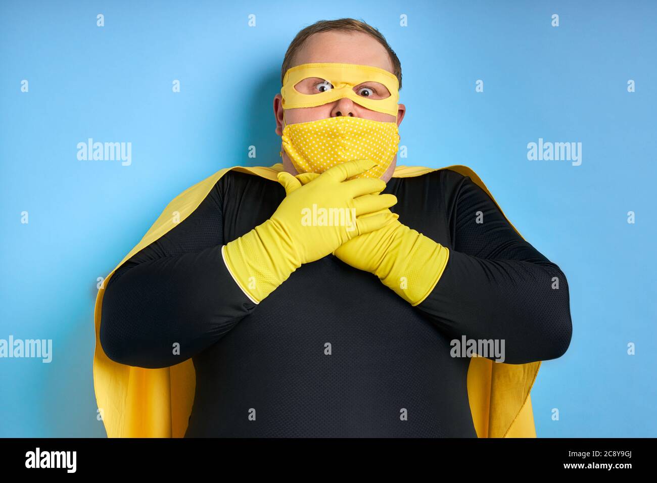 portrait of scared caucasian fat man in yellow mask, man stay in shock ...