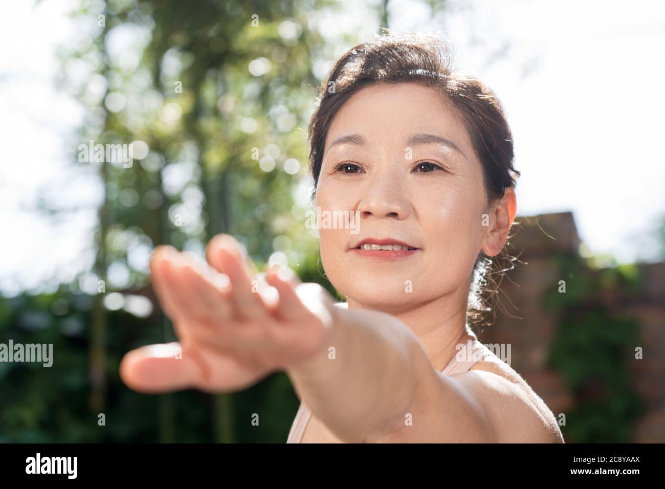 Happy old lady practice yoga outdoors Stock Photo - Alamy