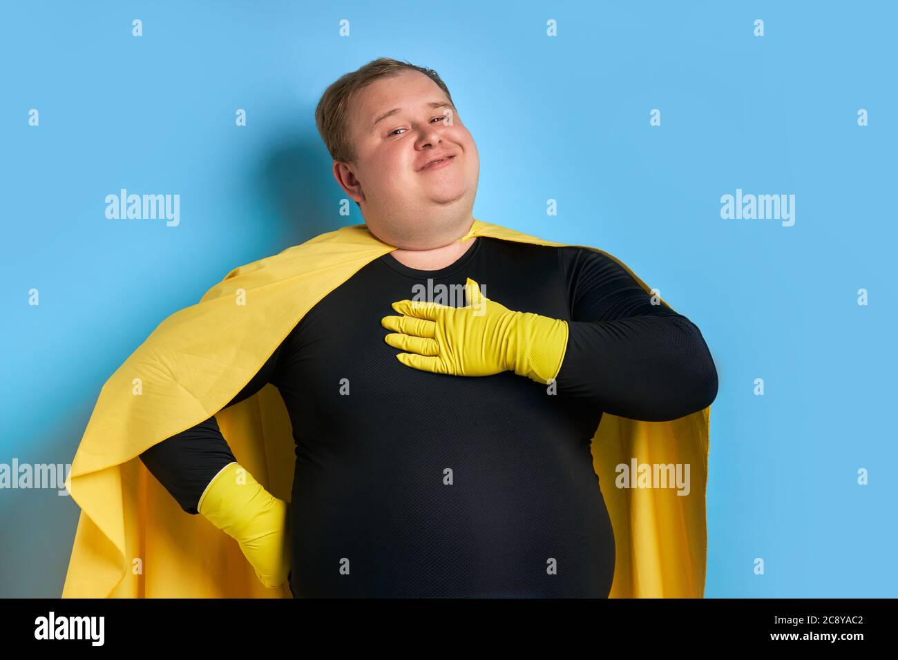 portrait of enthusiastic cleaning superhero isolated over blue ...