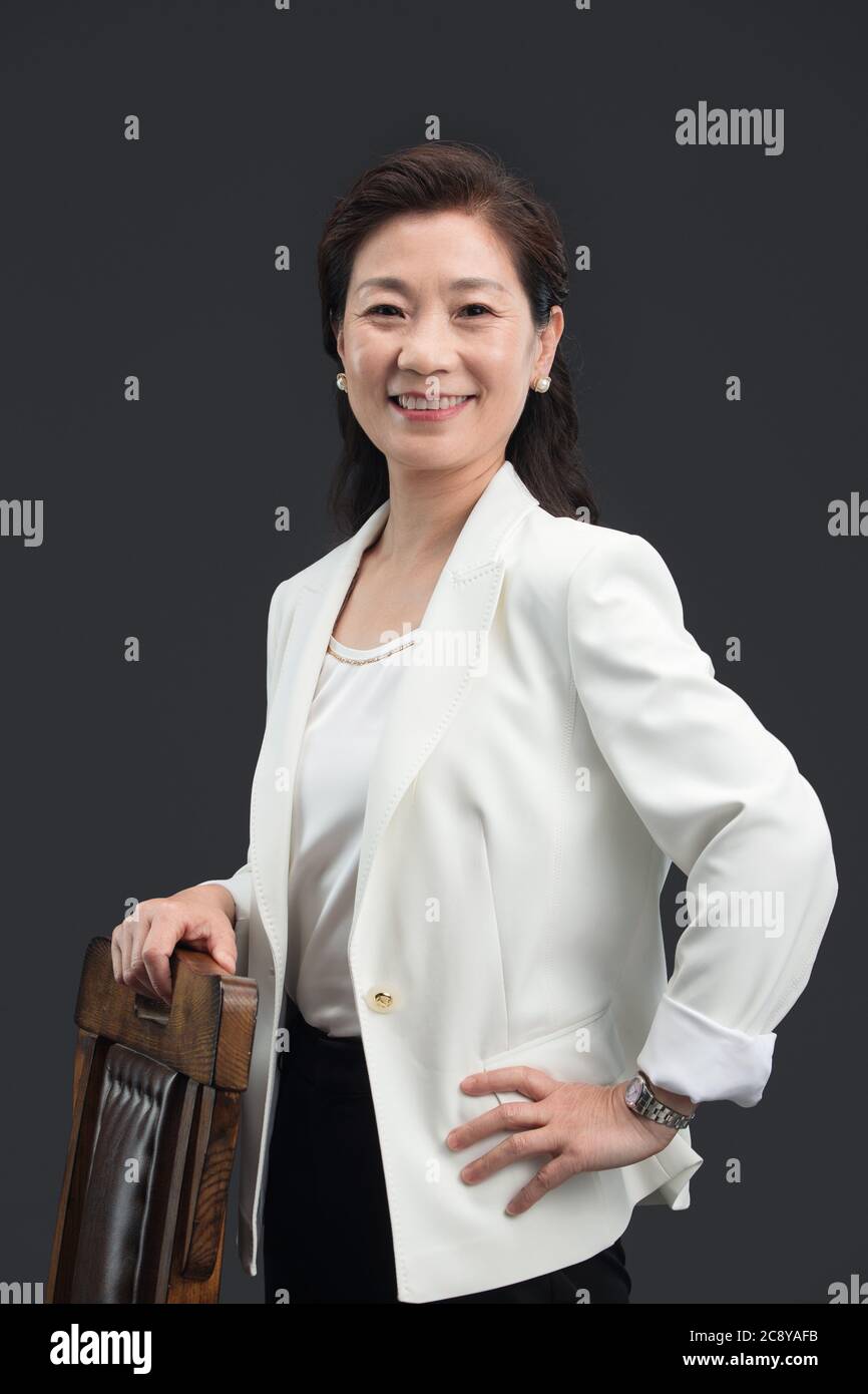 Holding back the old business lady Stock Photo - Alamy
