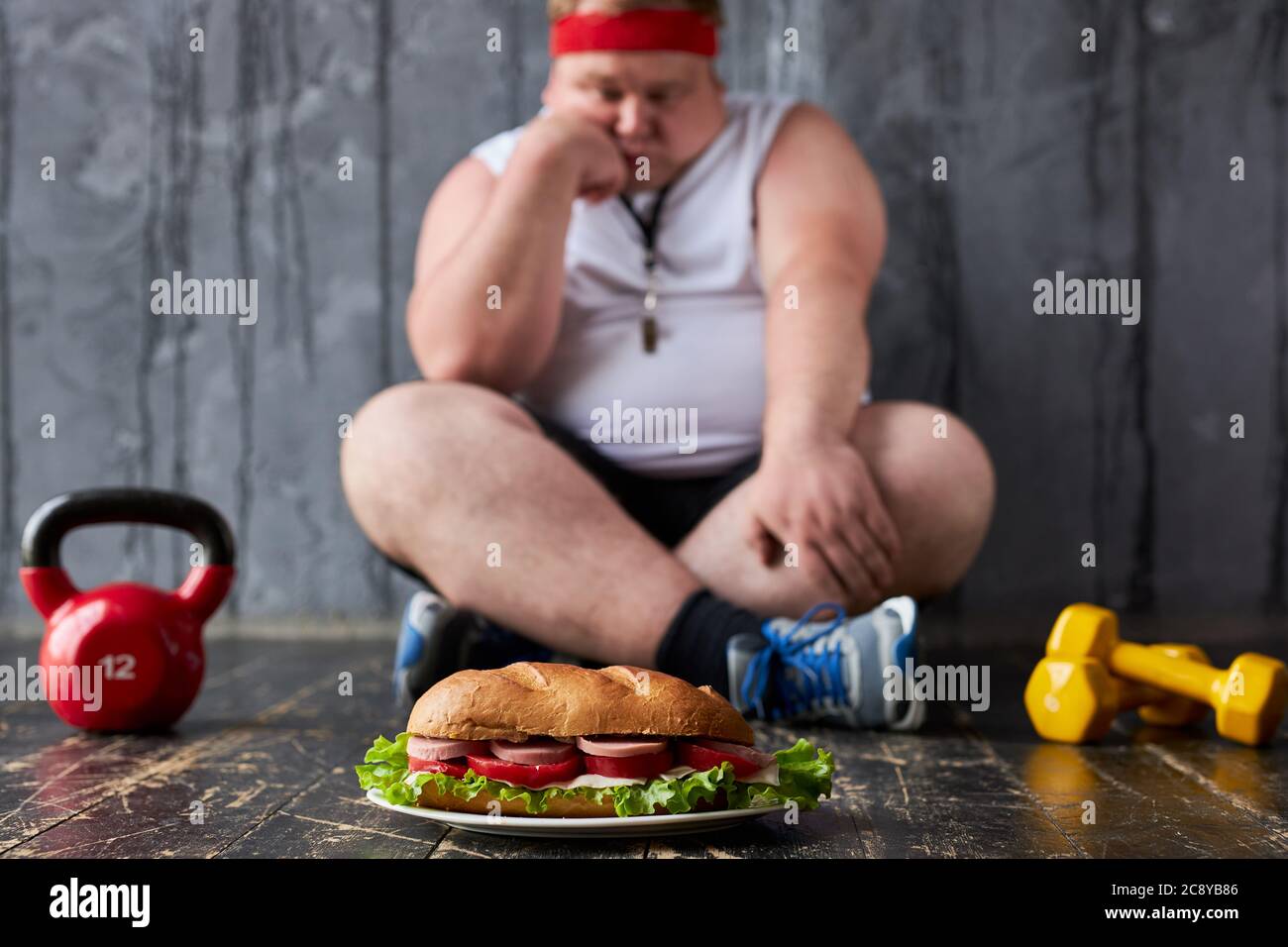 sad depressed fat guy wants to eat during sport exercises, fitness ...