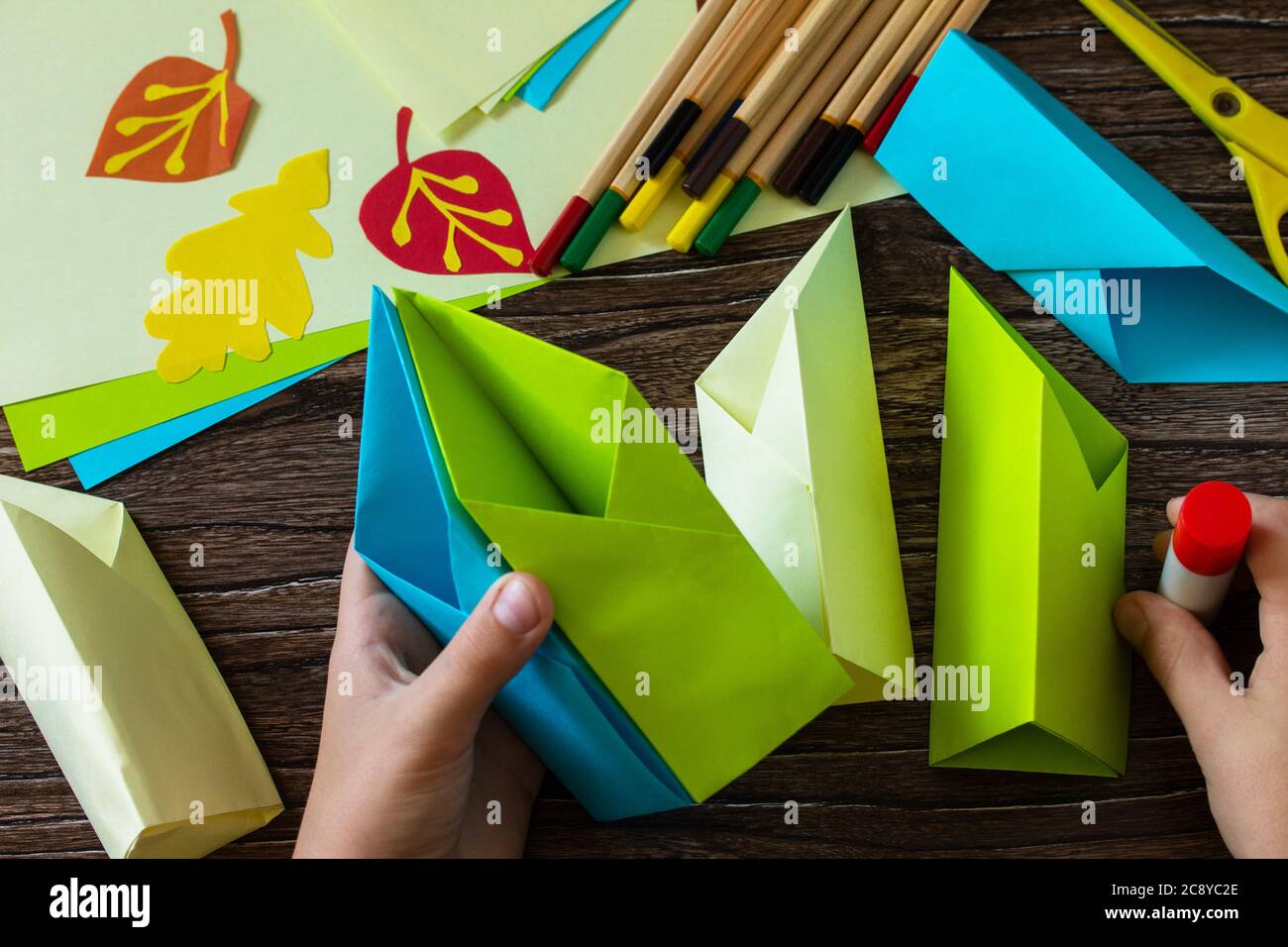 Instructions, step 10. Origami from paper Pencil Holder on wooden table ...