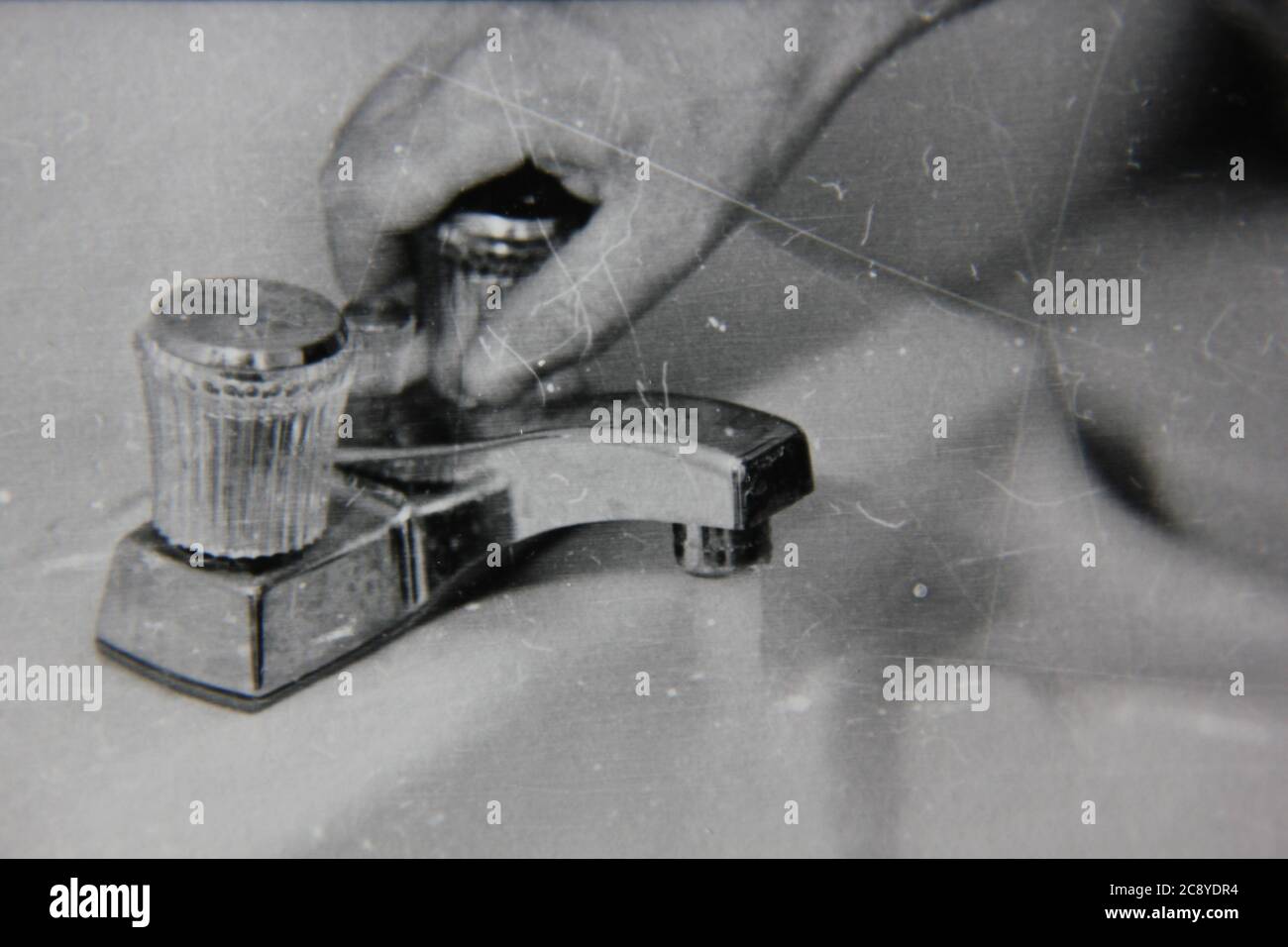 Fine 1970s vintage black and white photography of a hand turning a ...