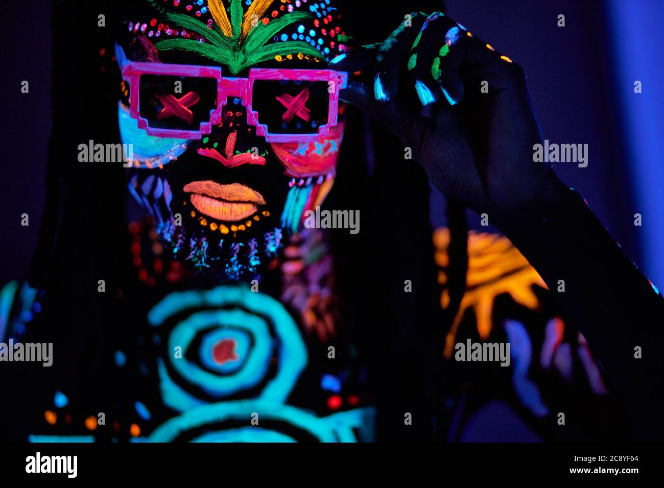 fantastic mysterious african male with UV body art posing at camera ...