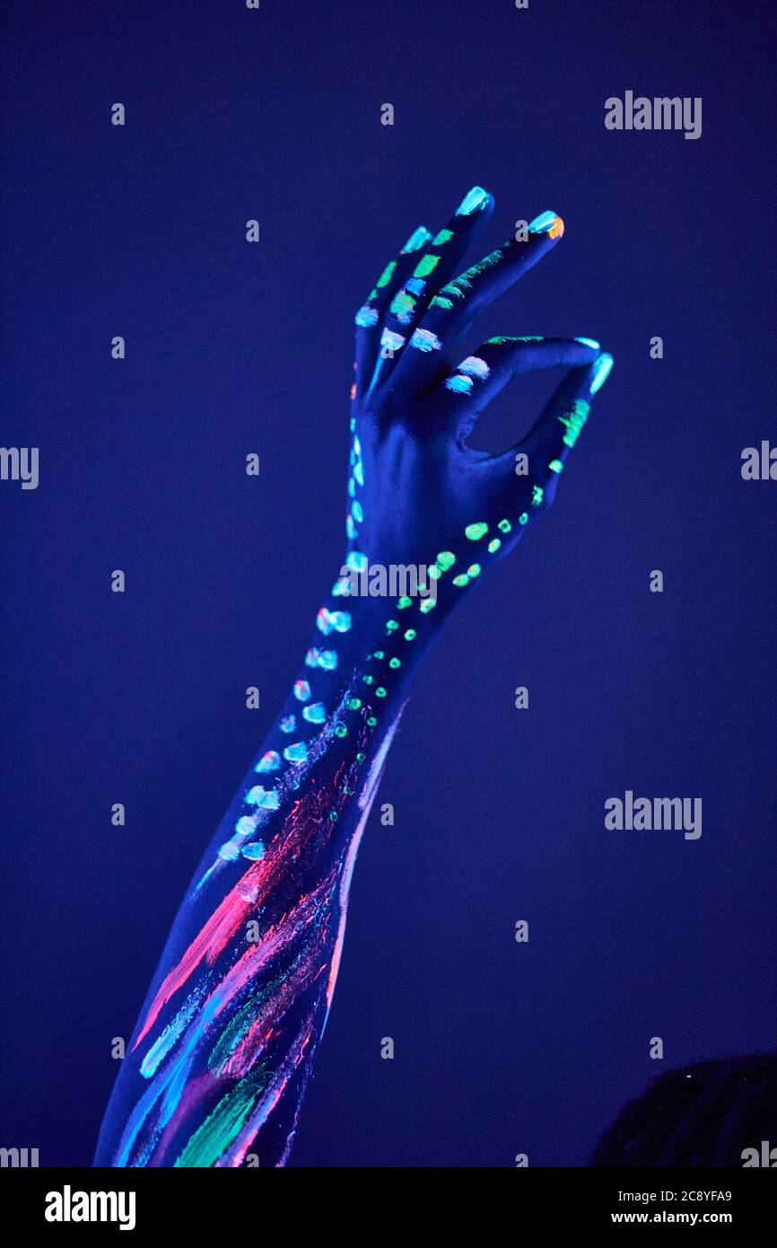 cropped photo of male hands showing OK gesture, fluorescent make-up ...