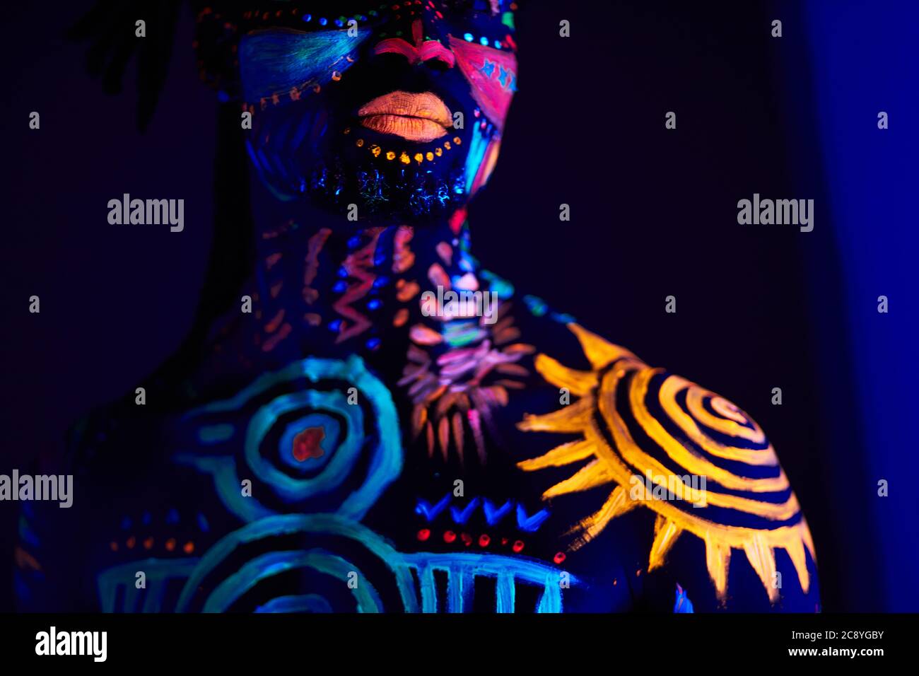 portrait of unrecognizable fashionable male model with fluorescent UV ...