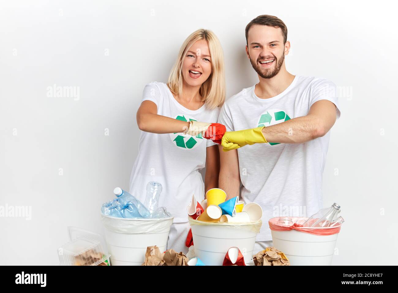 young couple rejoicing at successful day of recycling waste, man and ...
