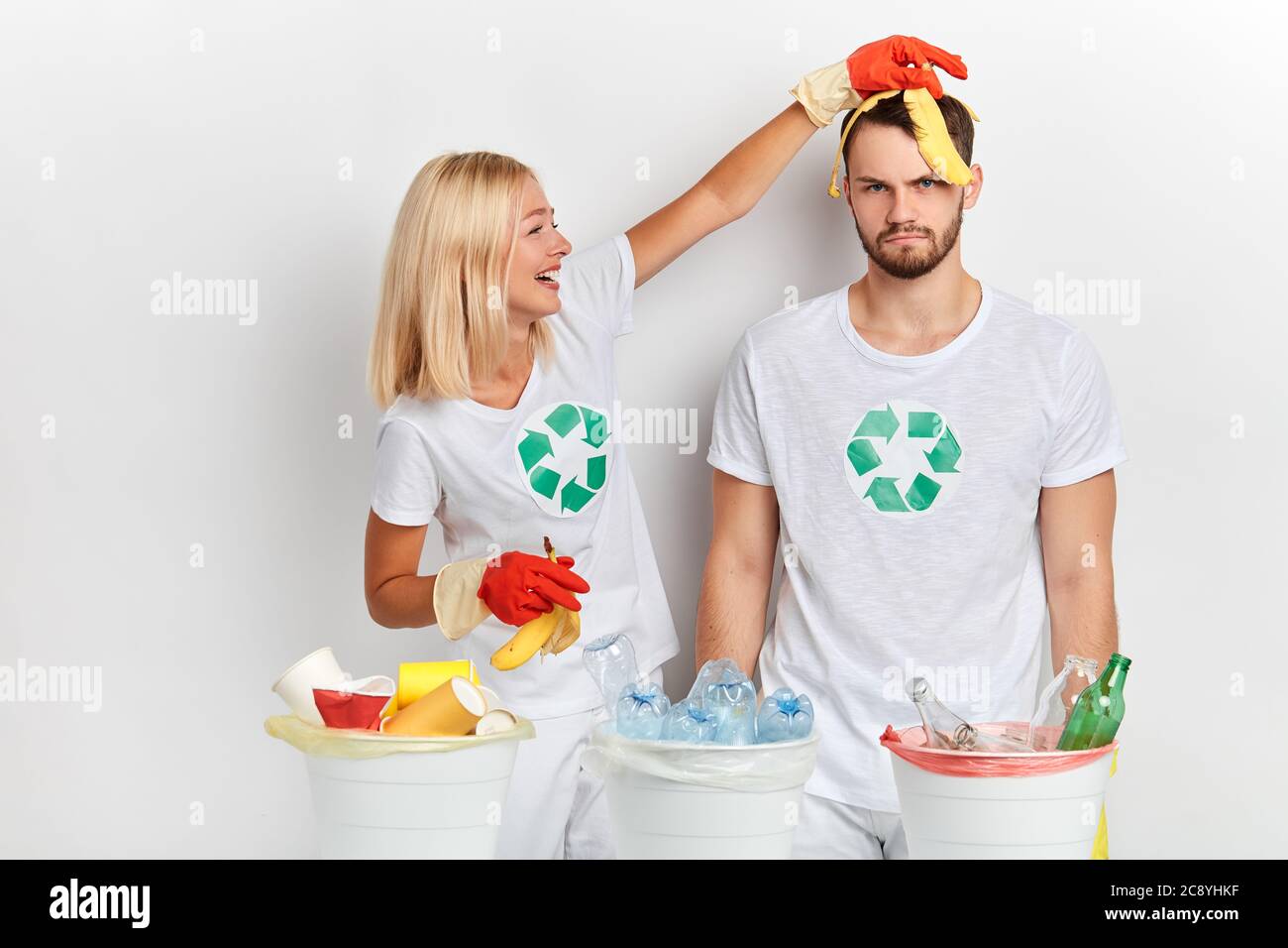 crazy girl in white T-shirt putting banana peel on her man's head ...