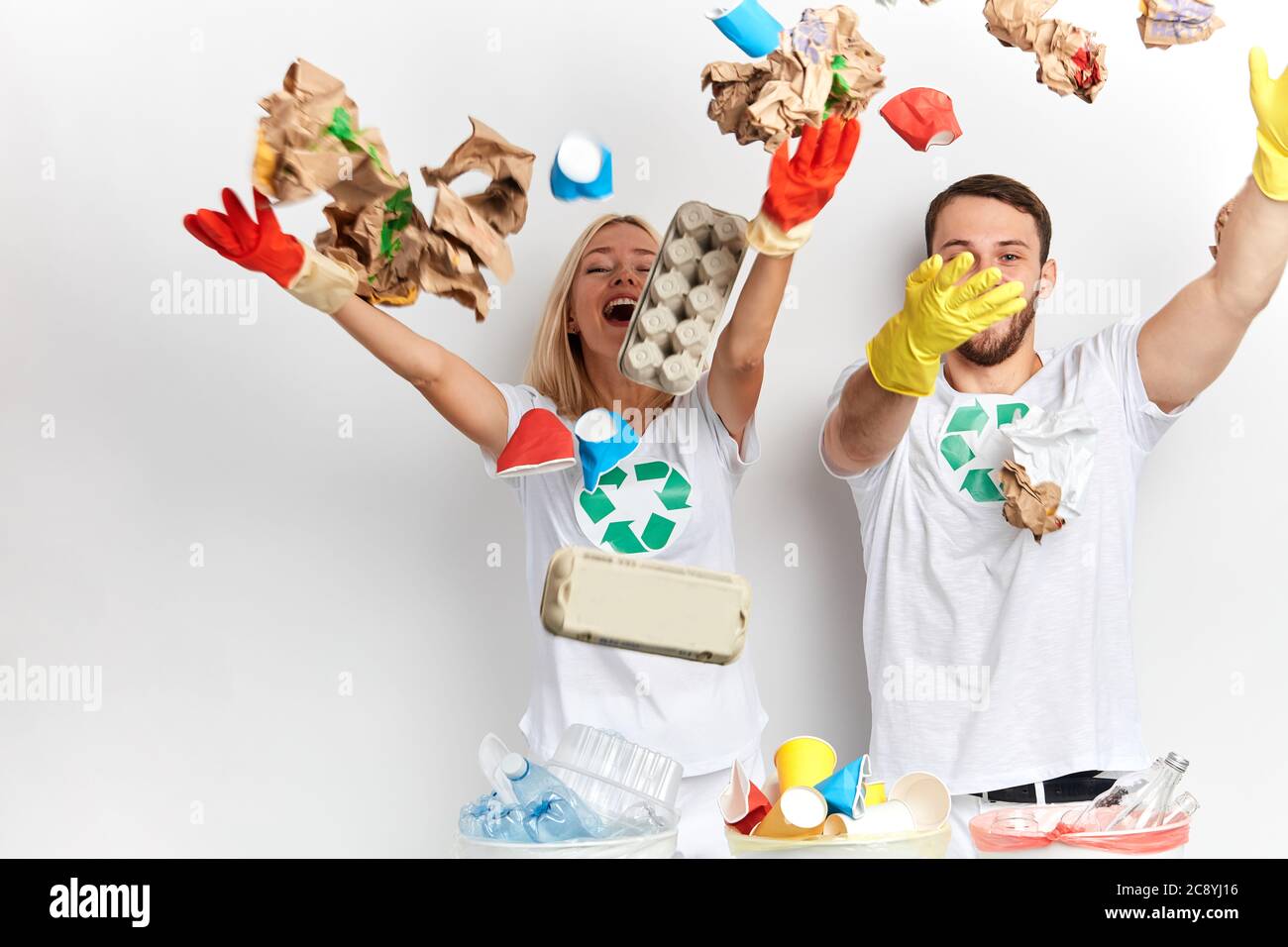excited happy young couple having fun with litter, isolated white ...