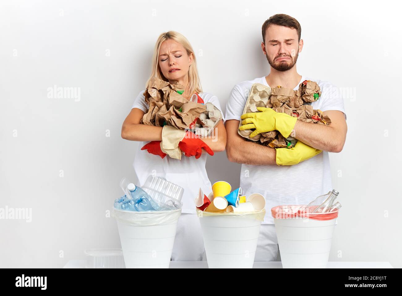 young couple with closed eyes hugging waste while standing behind the ...