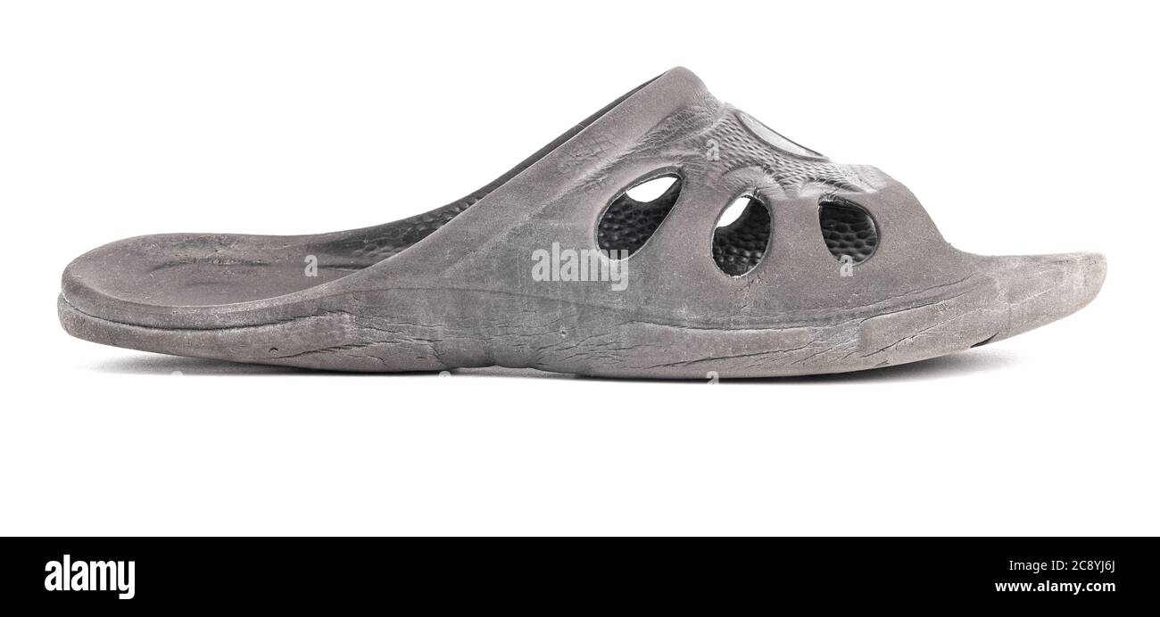 one used cheap black soft rubber slipper with signs of friction wear ...