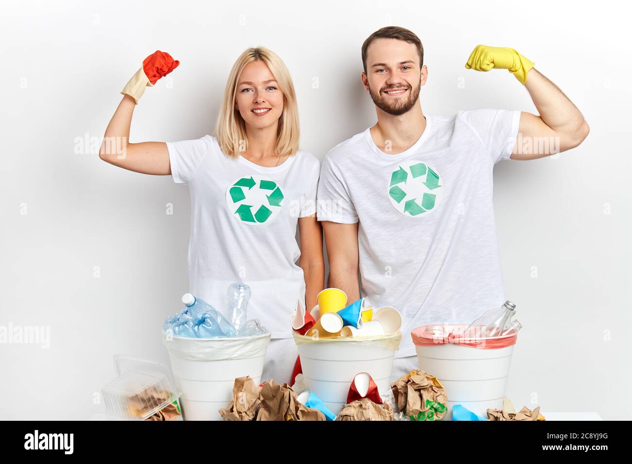 cheerful young man and woman showing their muscular while standing ...