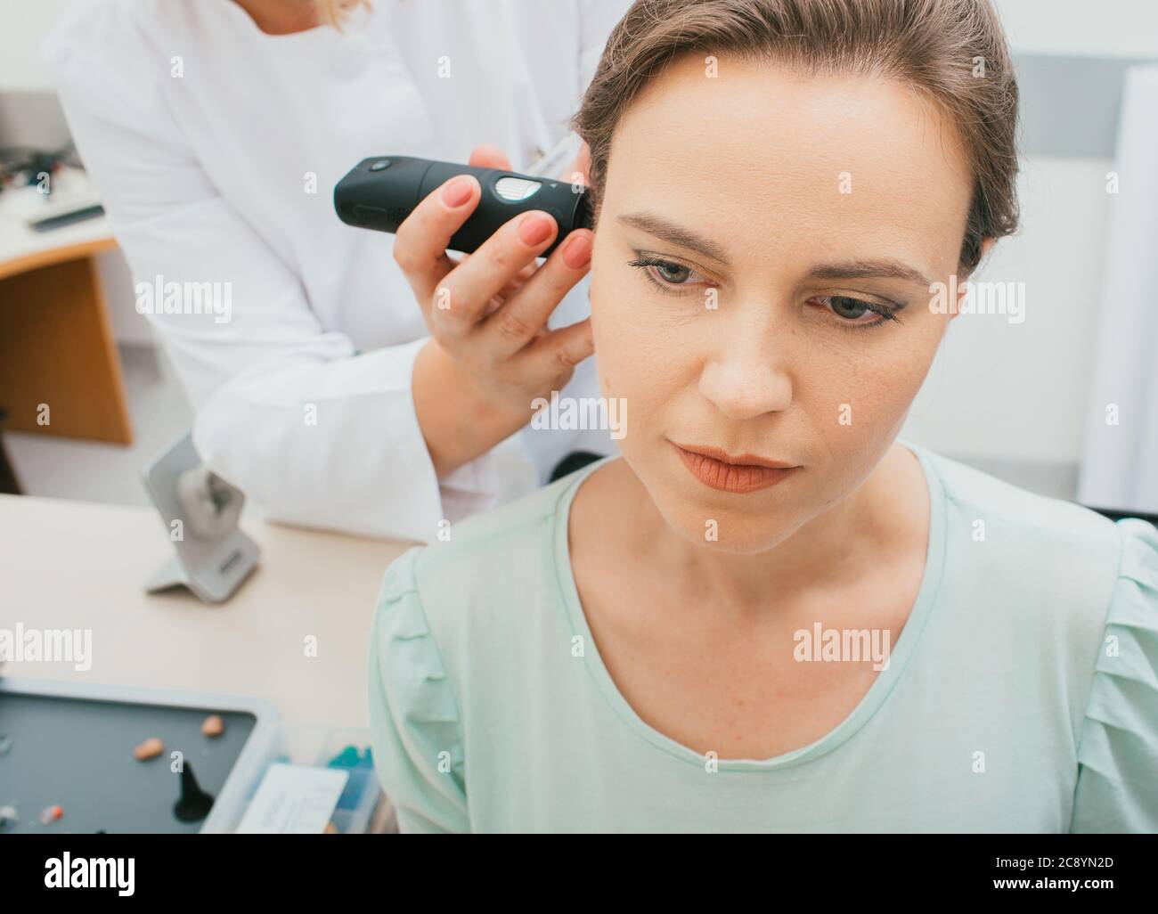 Female patient having ear video otoscopy procedures in an audiologist's ...