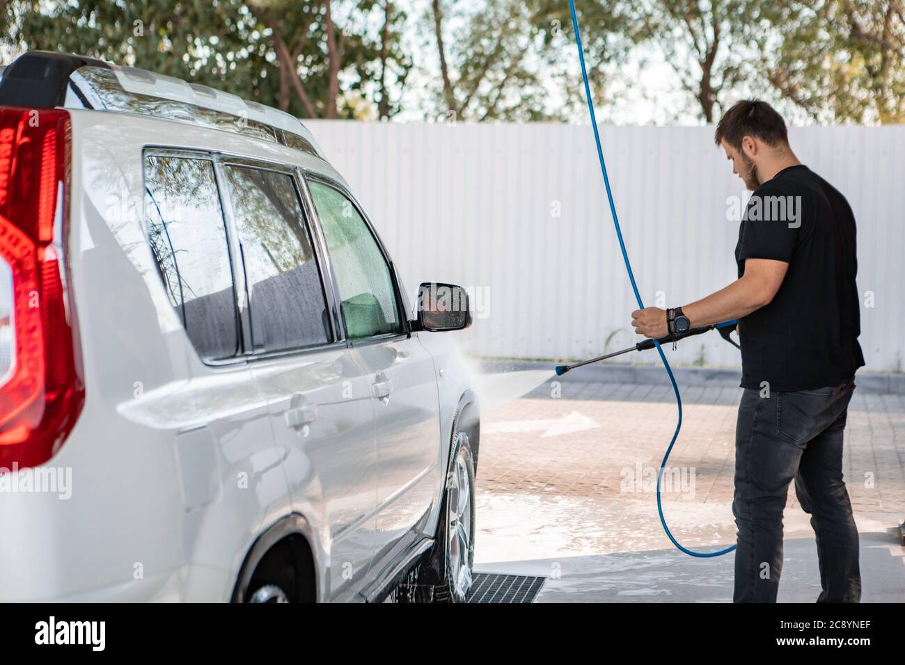 strong man washing car at self carwash outdoors Stock Photo - Alamy