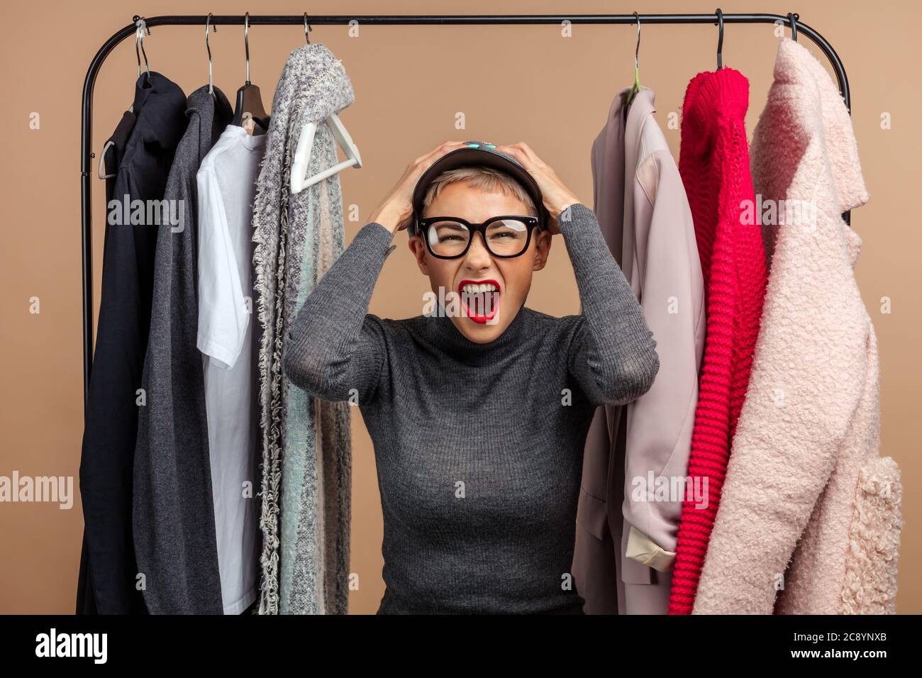 funny stylish woman screaming in the shopping mall. Isolated on pink ...
