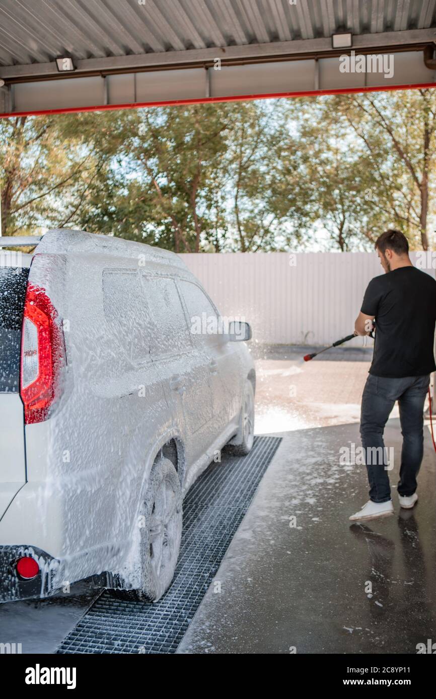strong man washing car at self carwash outdoors Stock Photo - Alamy