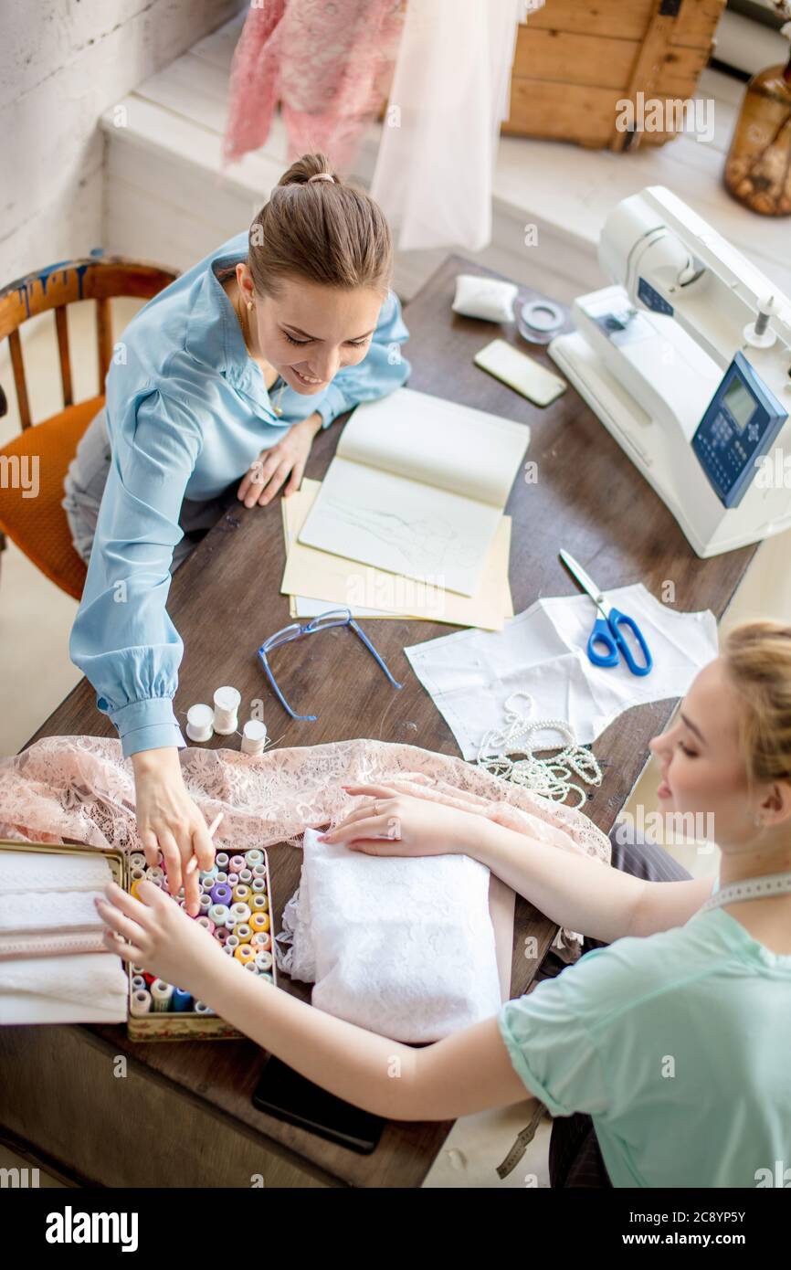 Couple of young beautiful business women starting their own small ...
