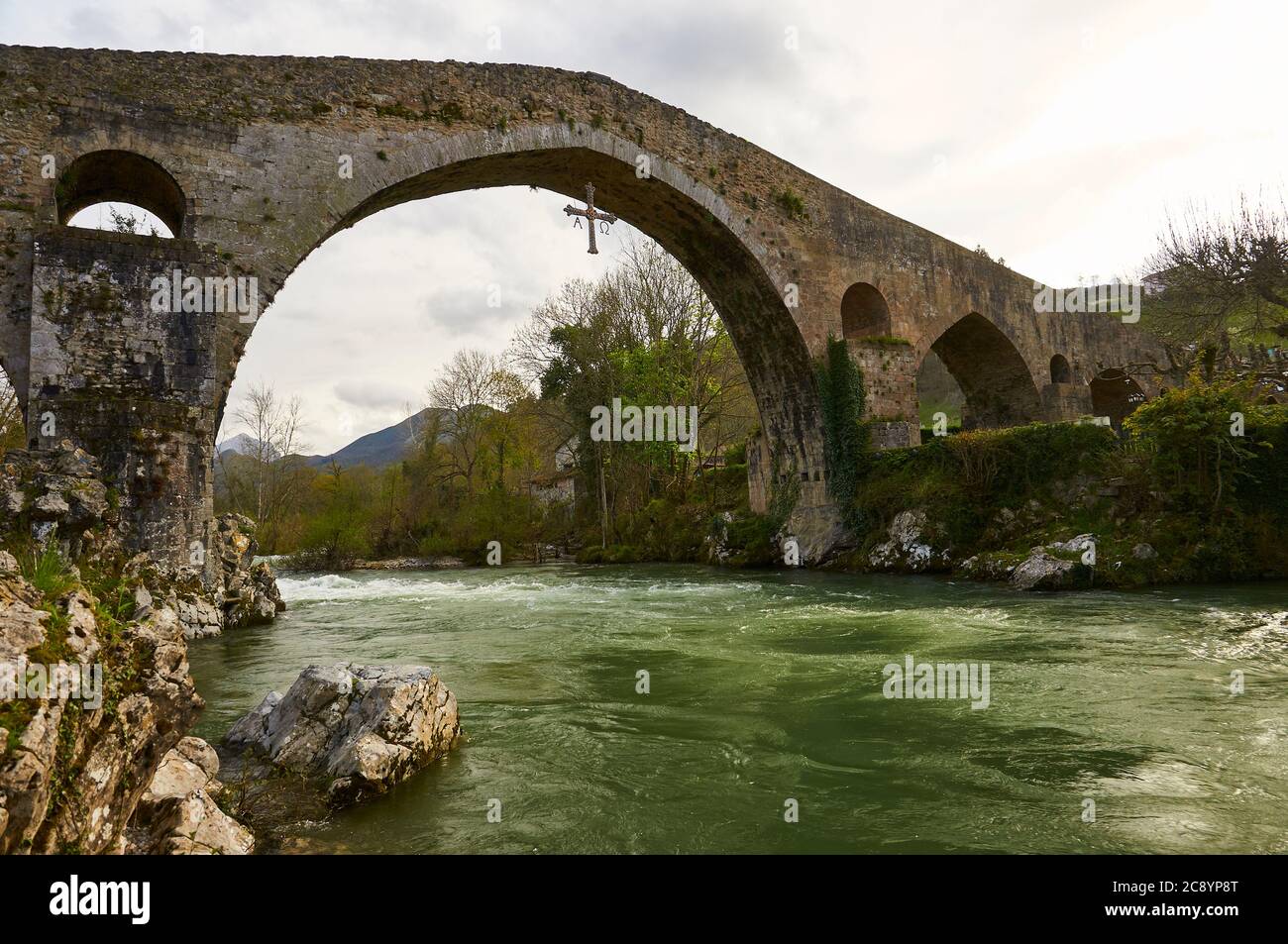 The Roman bridge with its Cruz de la Victoria Cross, symbol of Asturias ...