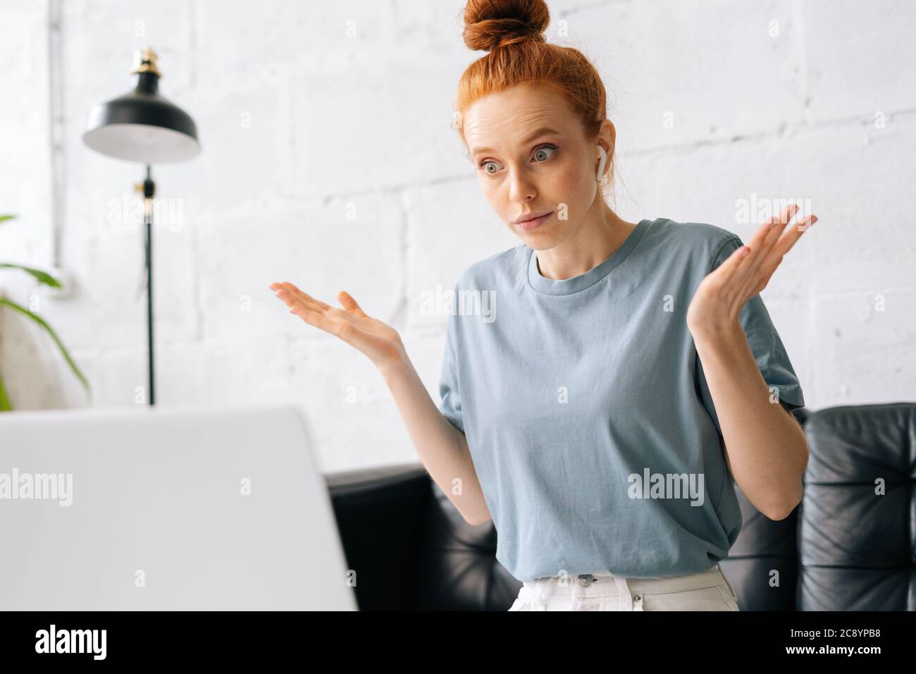 Shocked surprised beautiful redhead young woman is looking on display ...