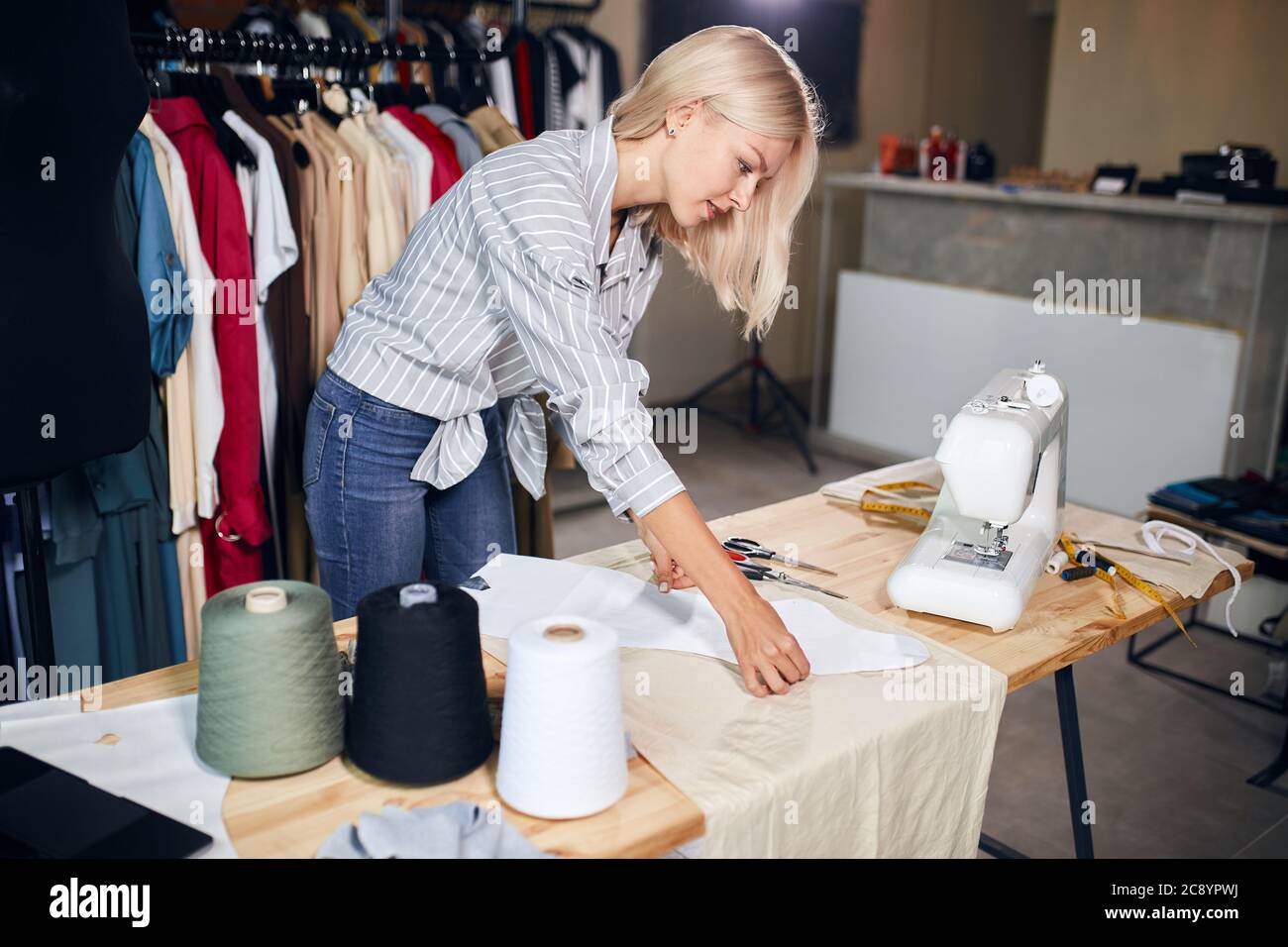 woman measuring fabric for new clothes, close up side view photo Stock ...